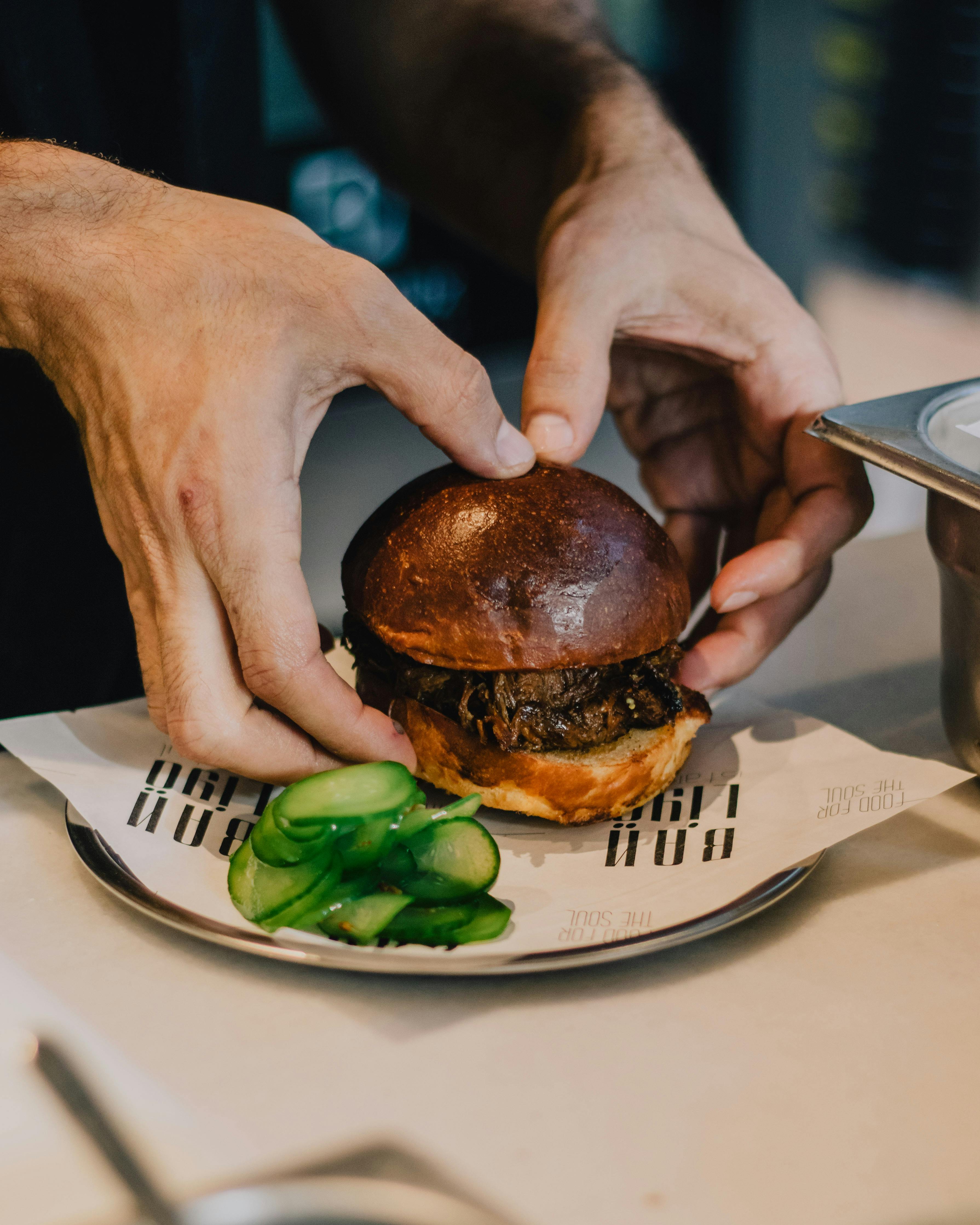 Hands Holding Hamburger · Free Stock Photo