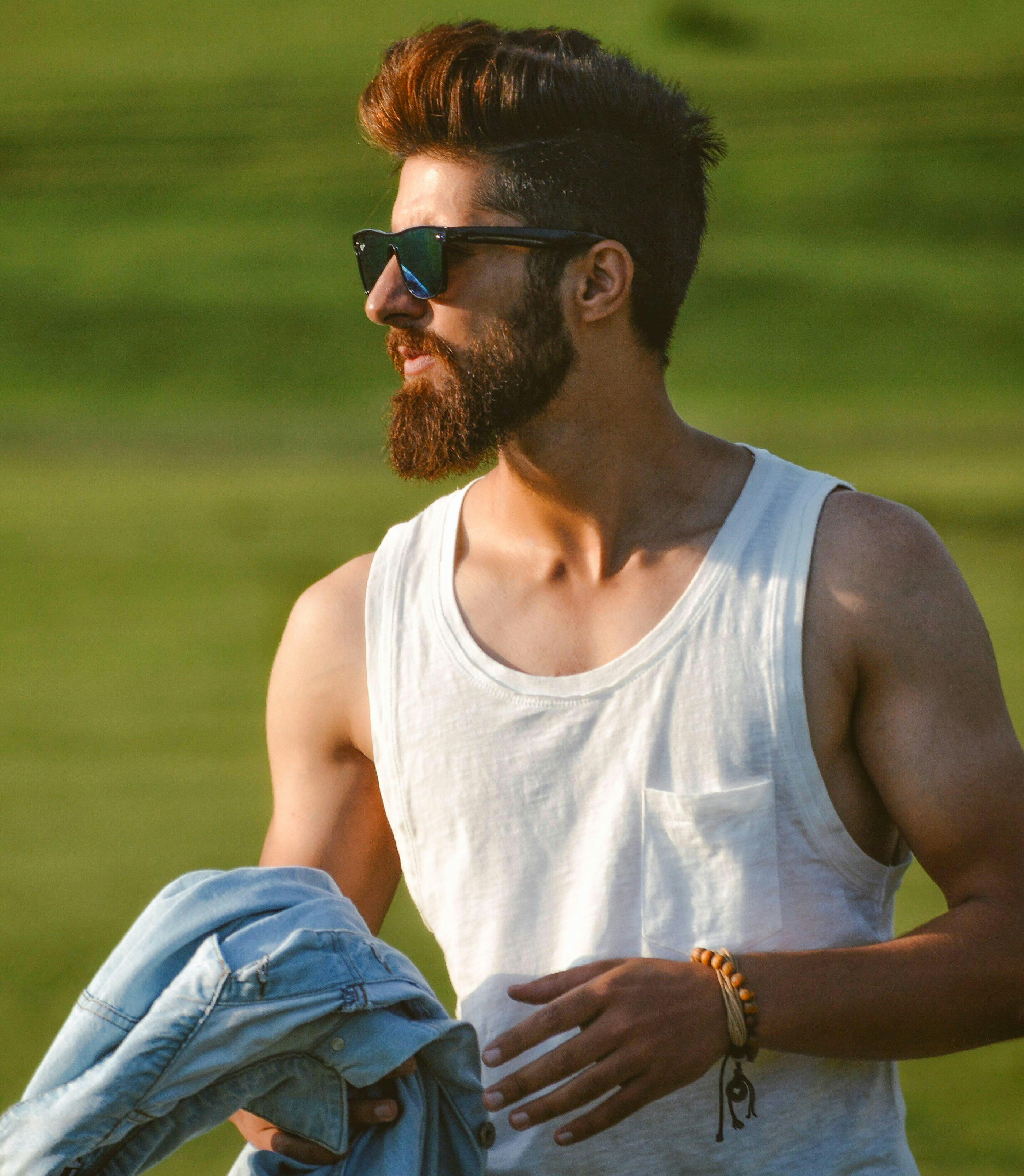 A Man in White Tank Top Wearing Black Sunglasses · Free Stock Photo