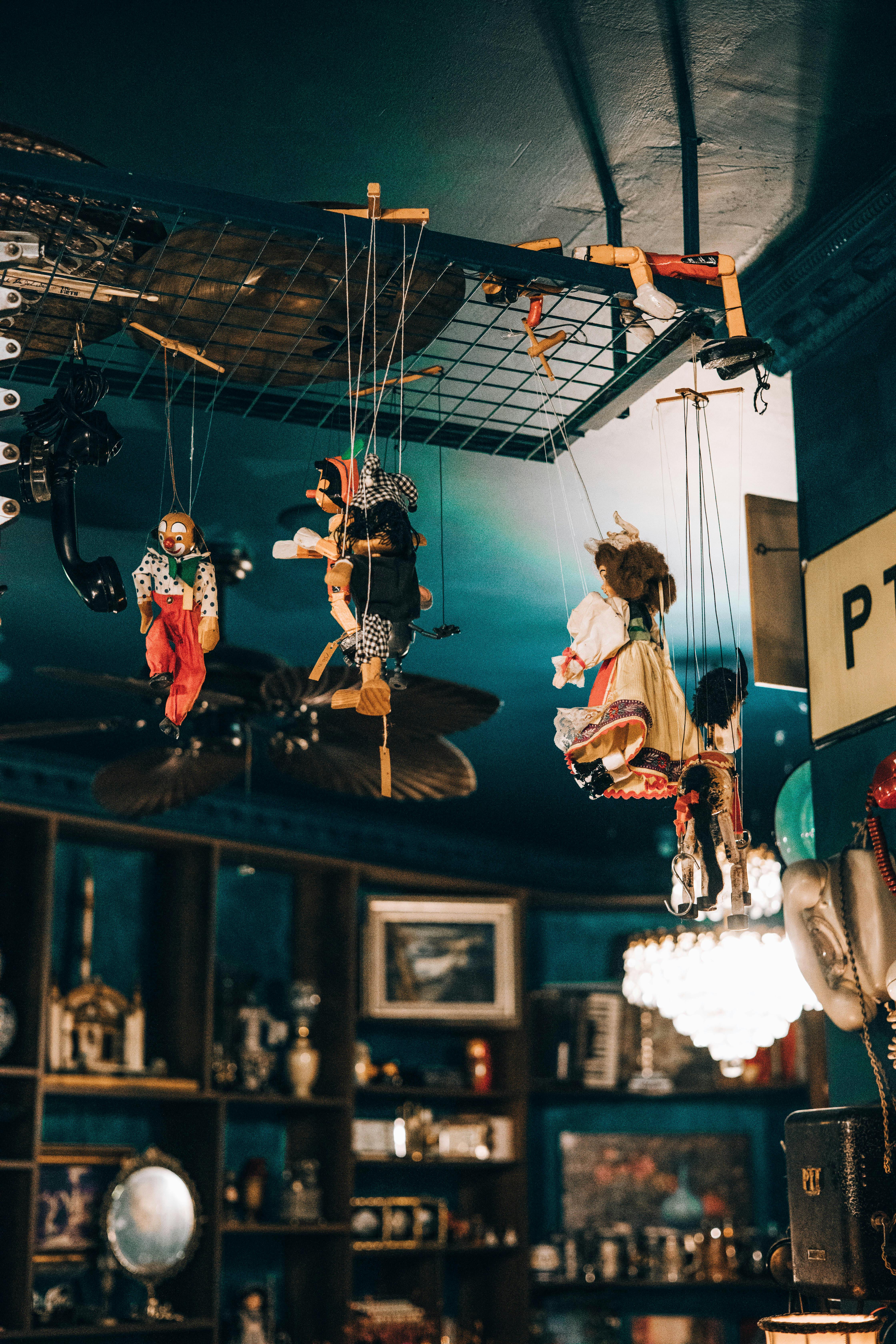 Low Angle Shot of Hanging Puppets · Free Stock Photo