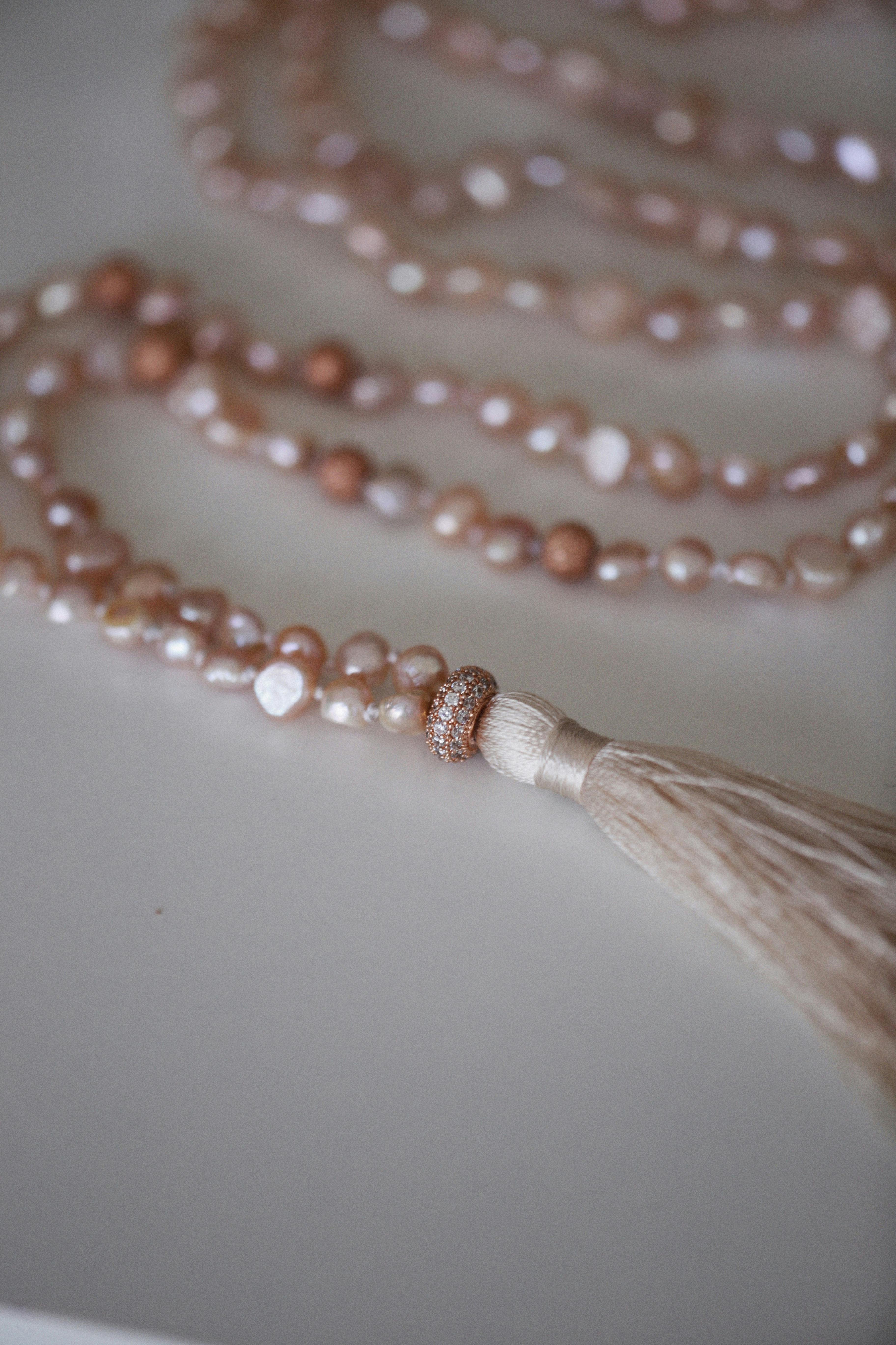 Close-up of a String with Pink Pearls · Free Stock Photo