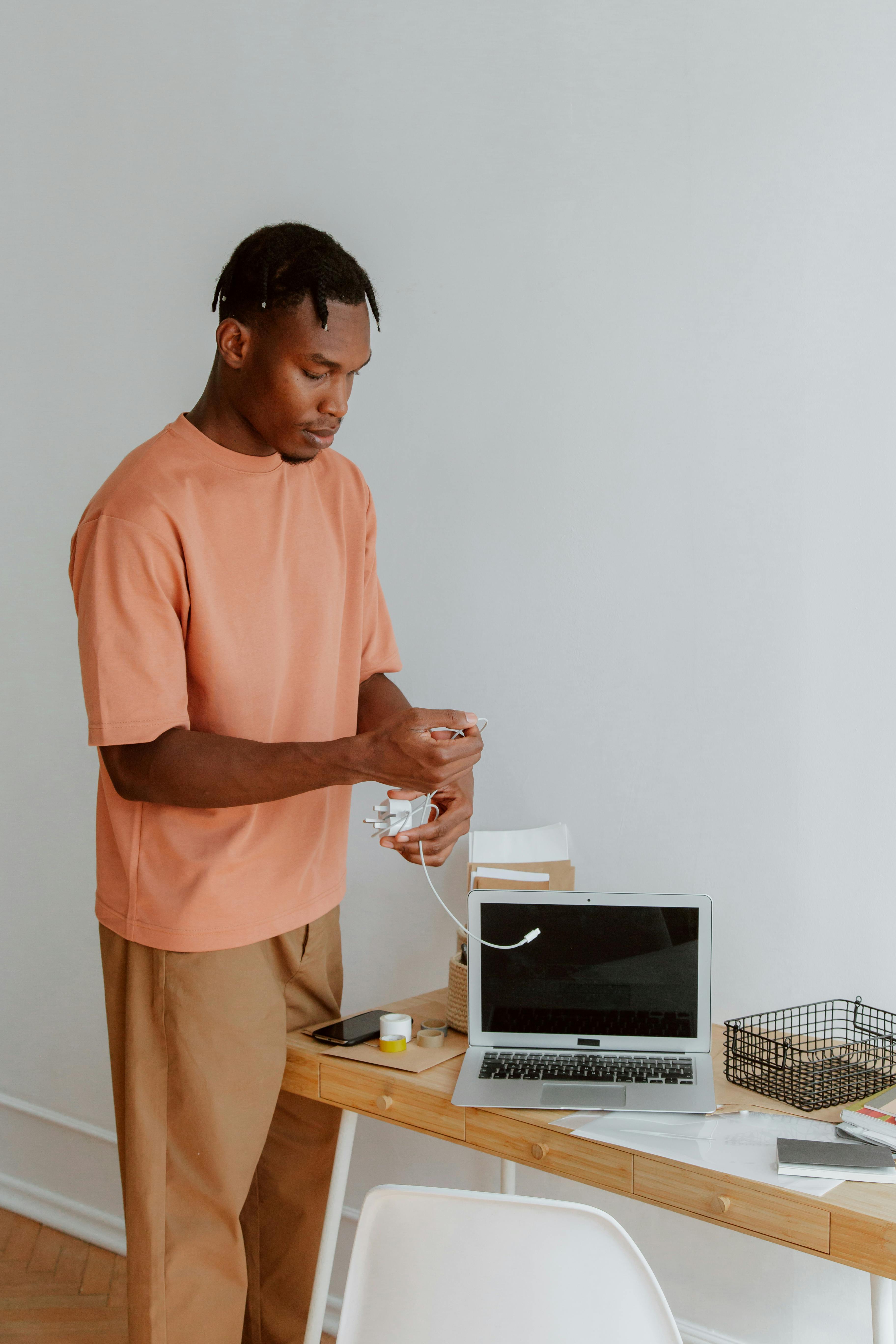 Man Standing Next to Desk · Free Stock Photo