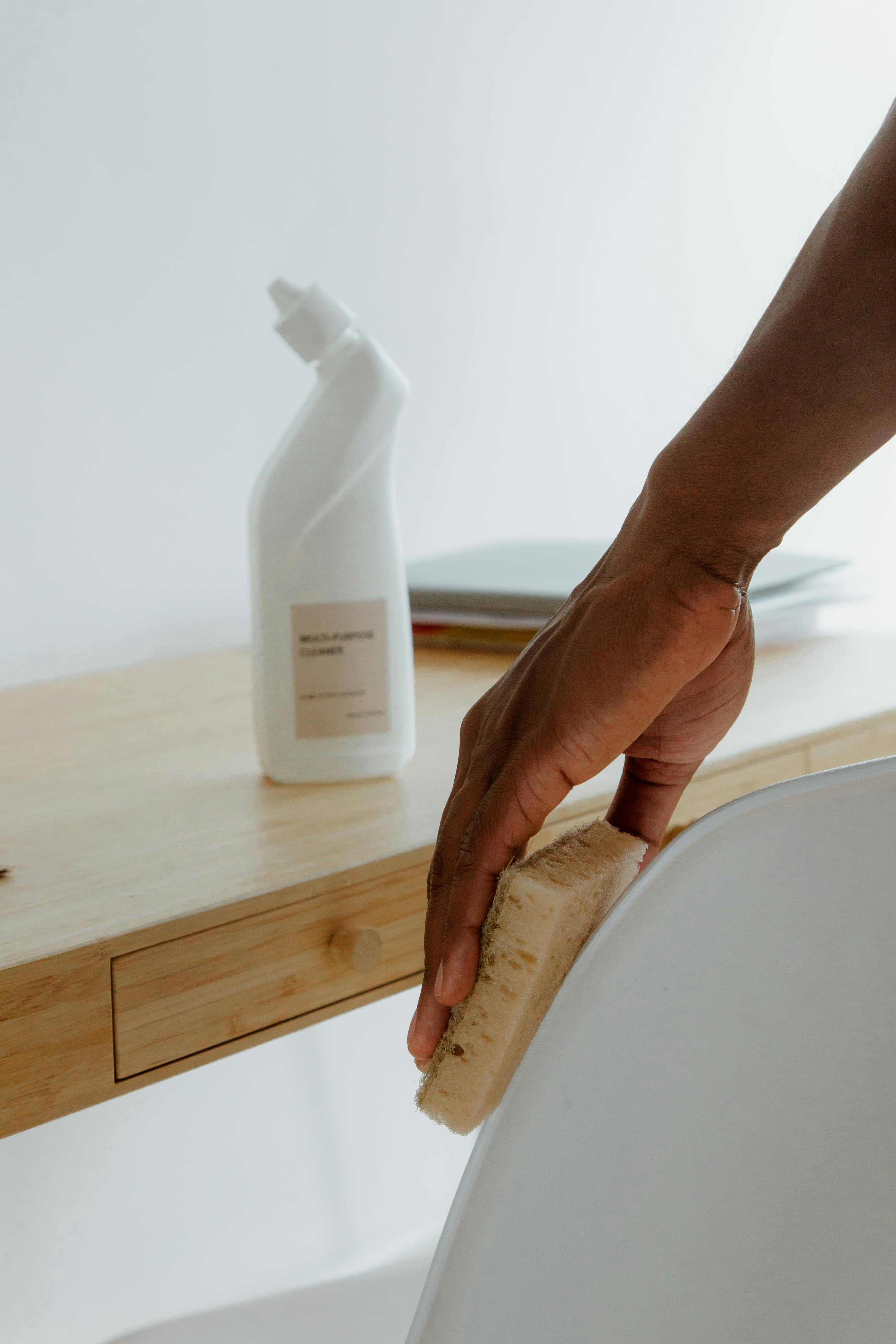 Man Cleaning Desk Area with Sponge · Free Stock Photo