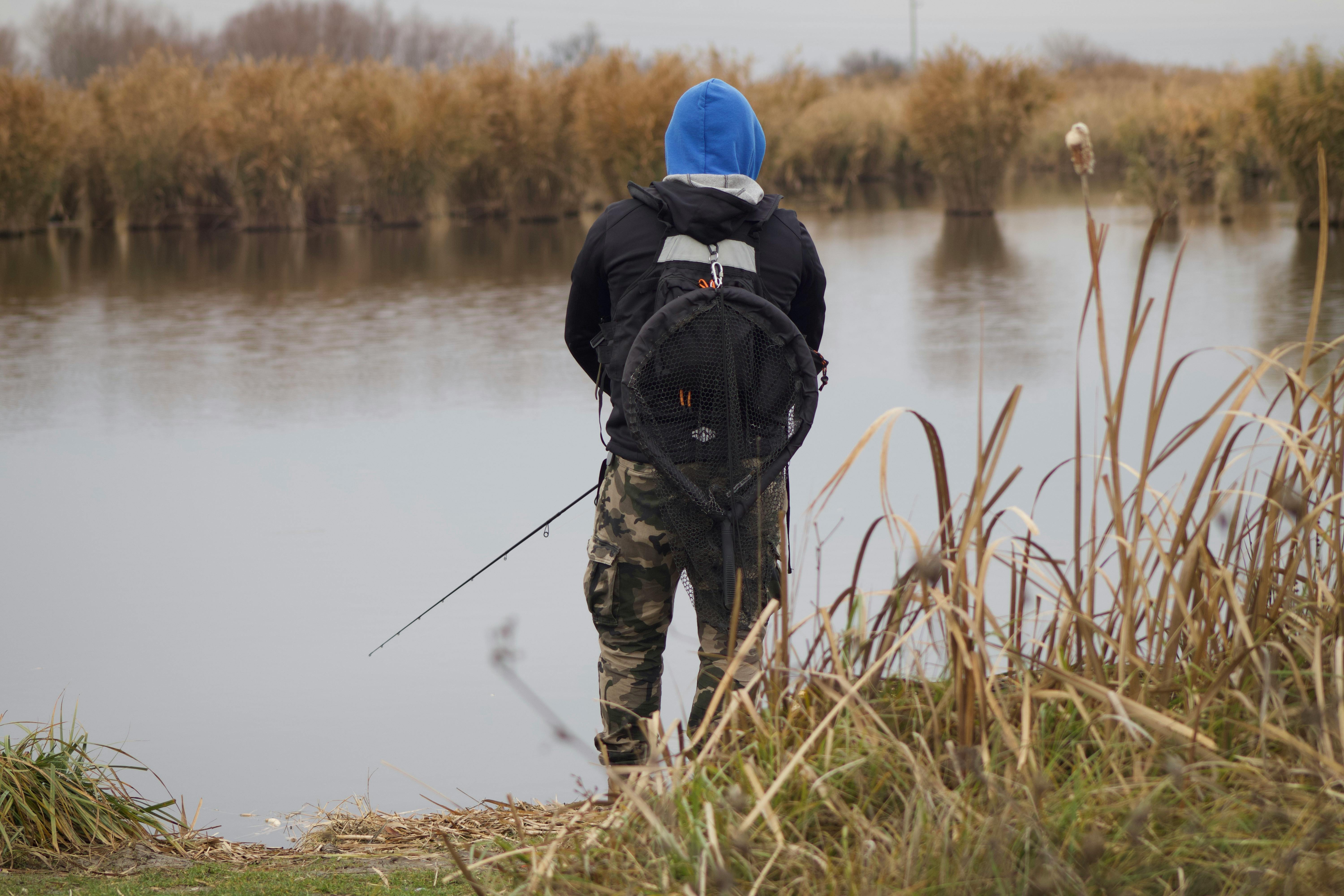 Person on White Boat Fishing on Body of Water · Free Stock Photo