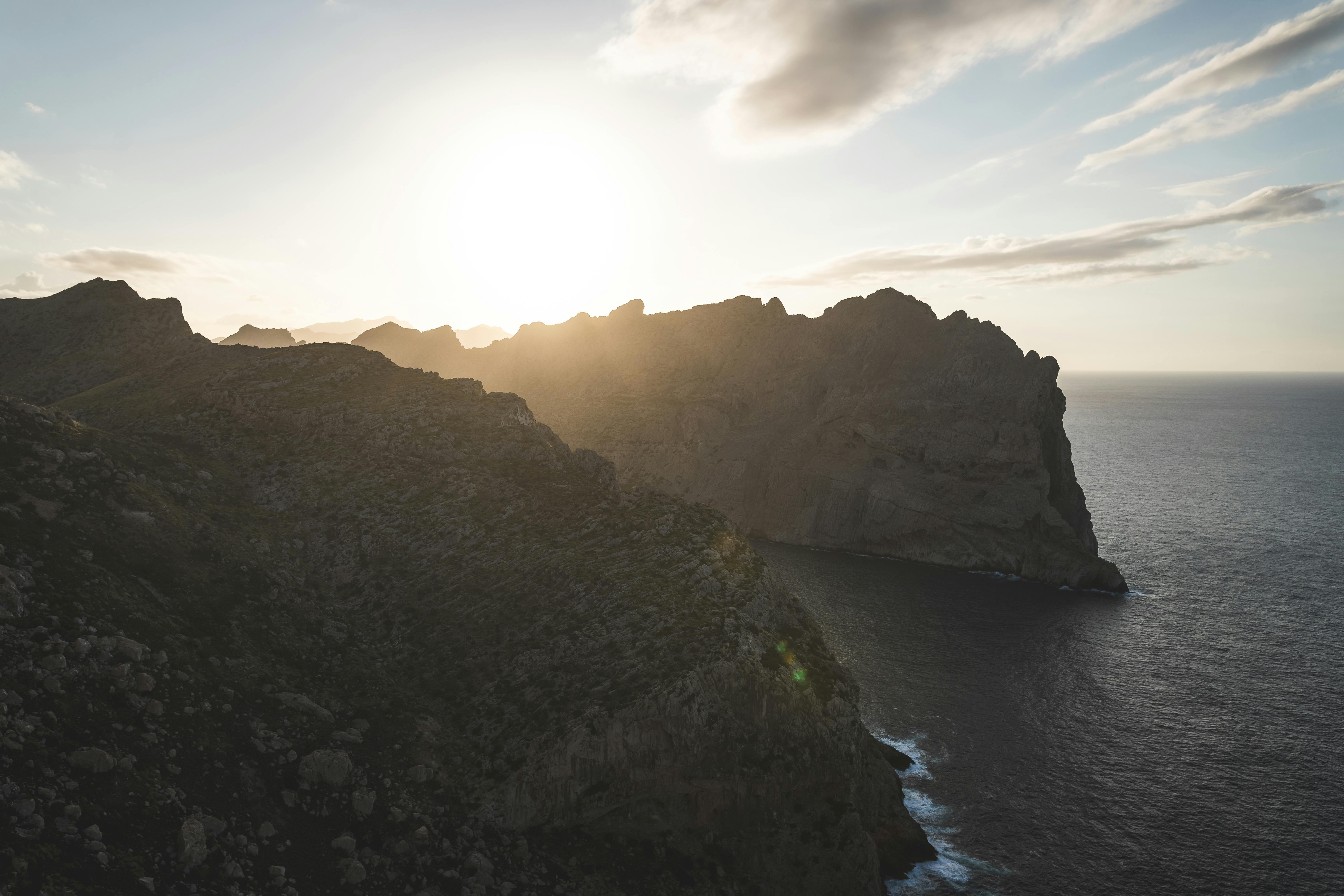 Aerial Photography of Mountains near Ocean during Sunset · Free Stock Photo