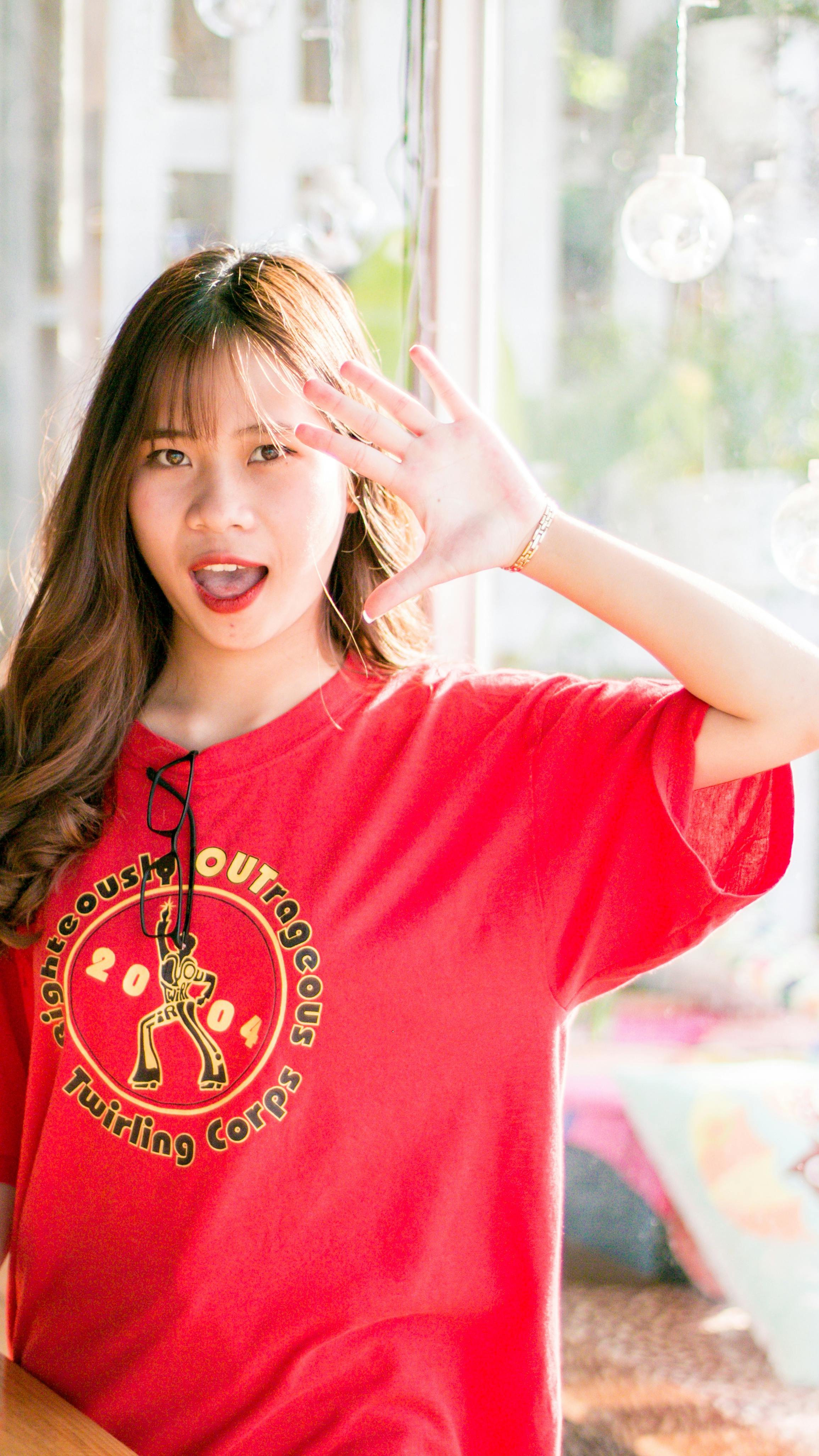 Woman Wearing Red Shirt Sitting on Bench Near Tree · Free Stock Photo