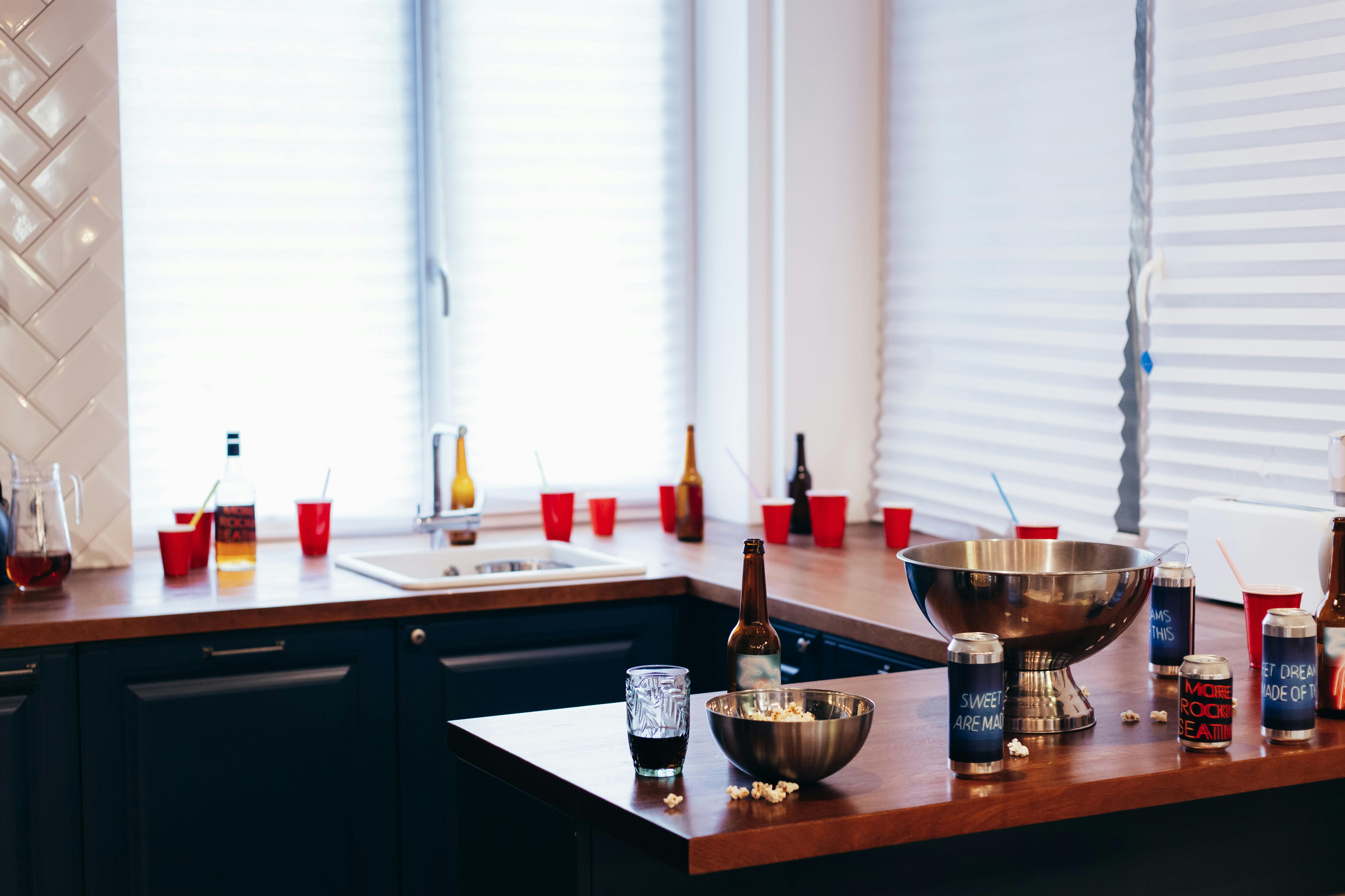 Red Plastic Cups on Brown Wooden Counter Top · Free Stock Photo