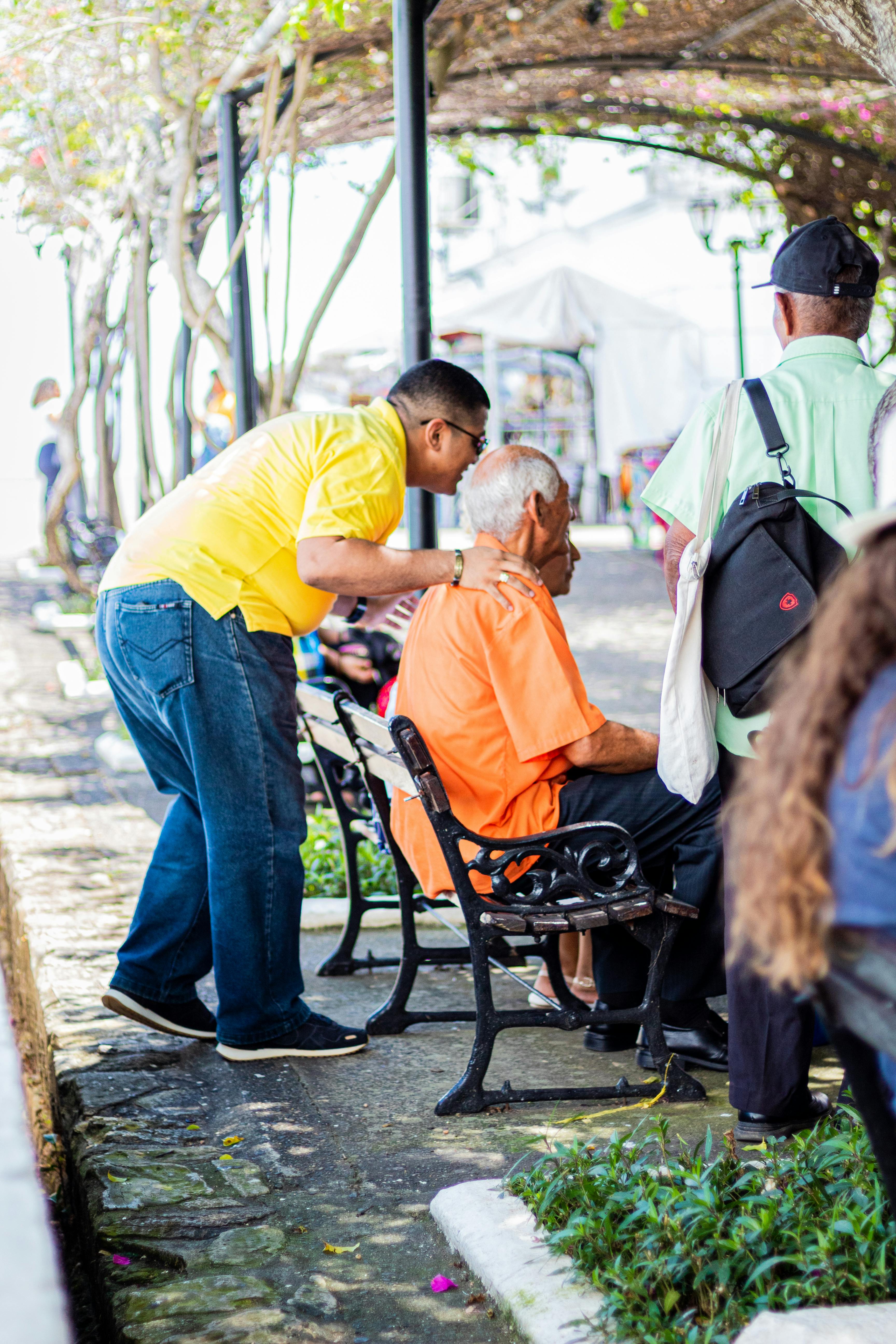 Eldery Men Sitting on the Bench with their Caretaker at the Back · Free ...