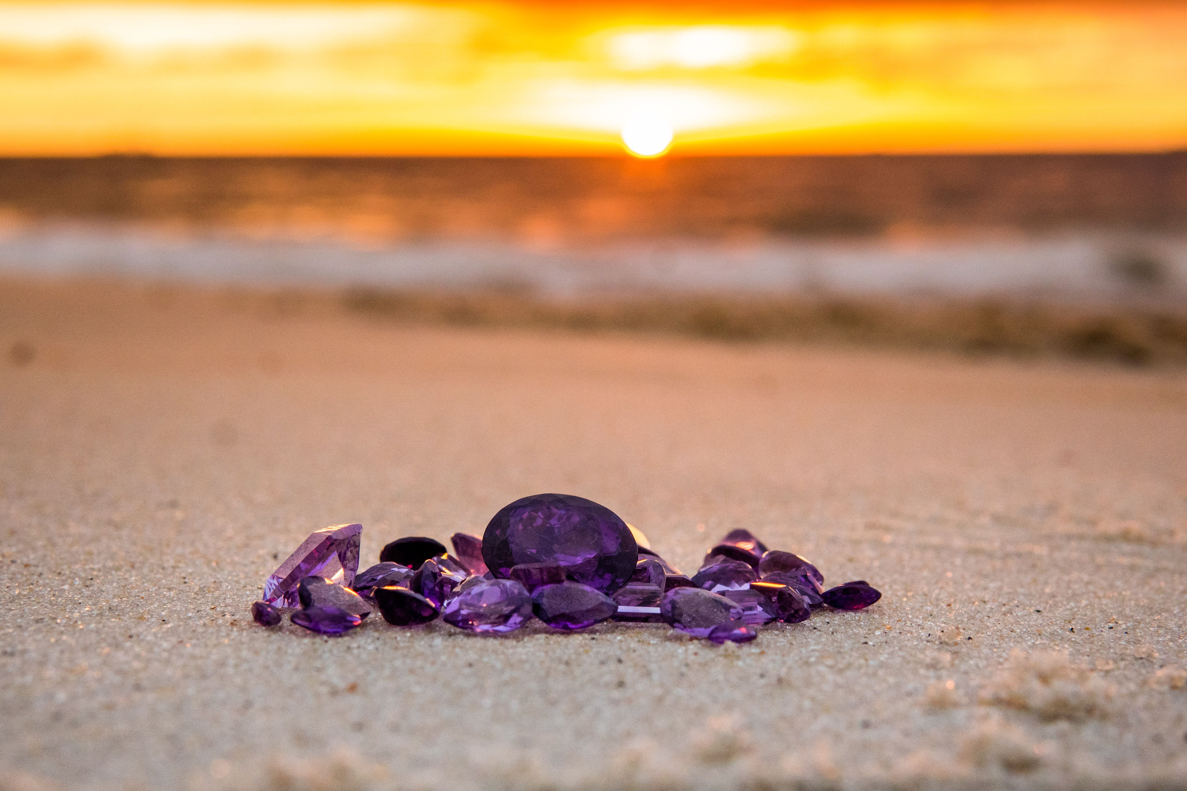 A Close-Up Shot of Gems on Sand · Free Stock Photo