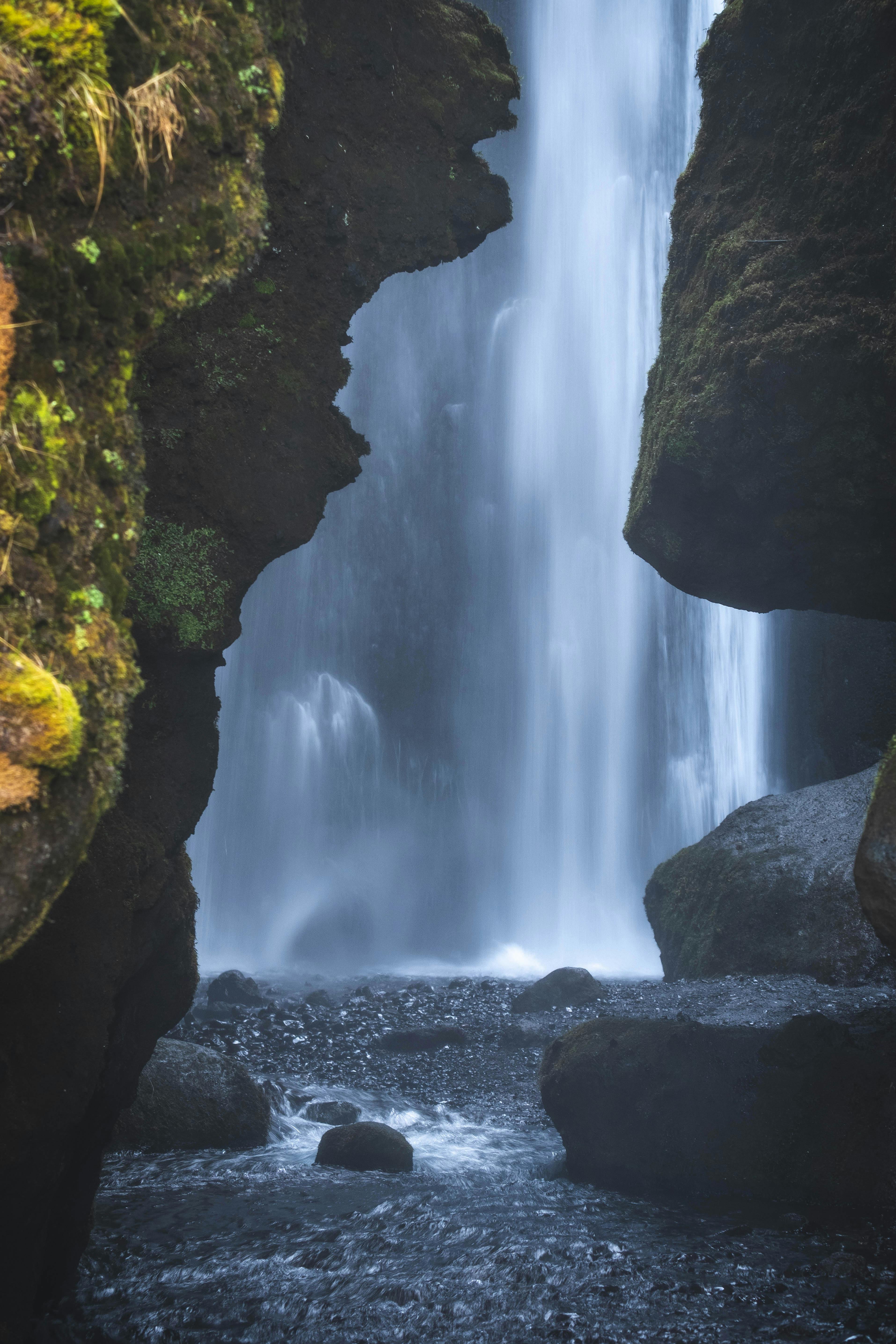 Rocks and Waterfall behind · Free Stock Photo
