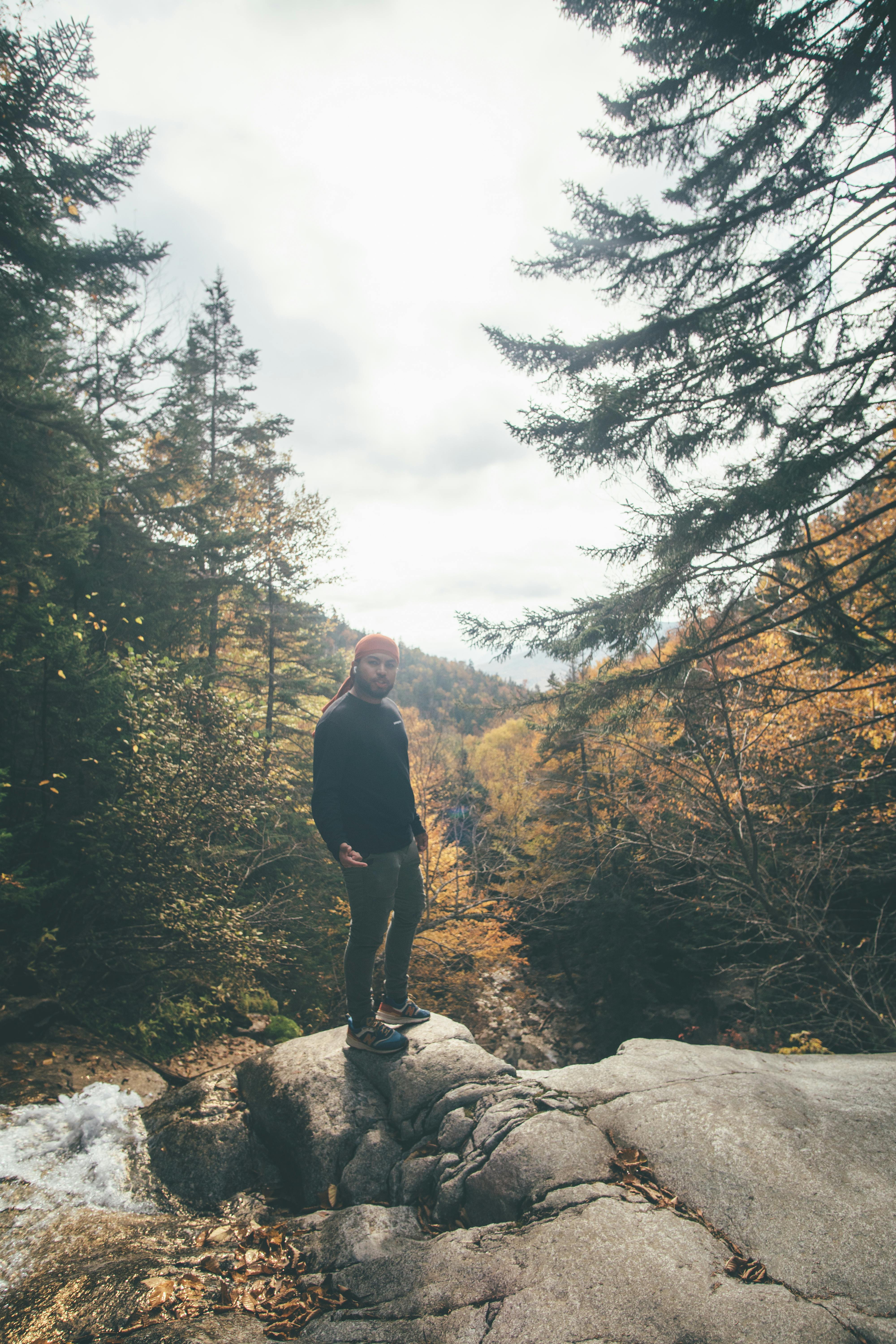 A Man Standing on Big Rocks · Free Stock Photo