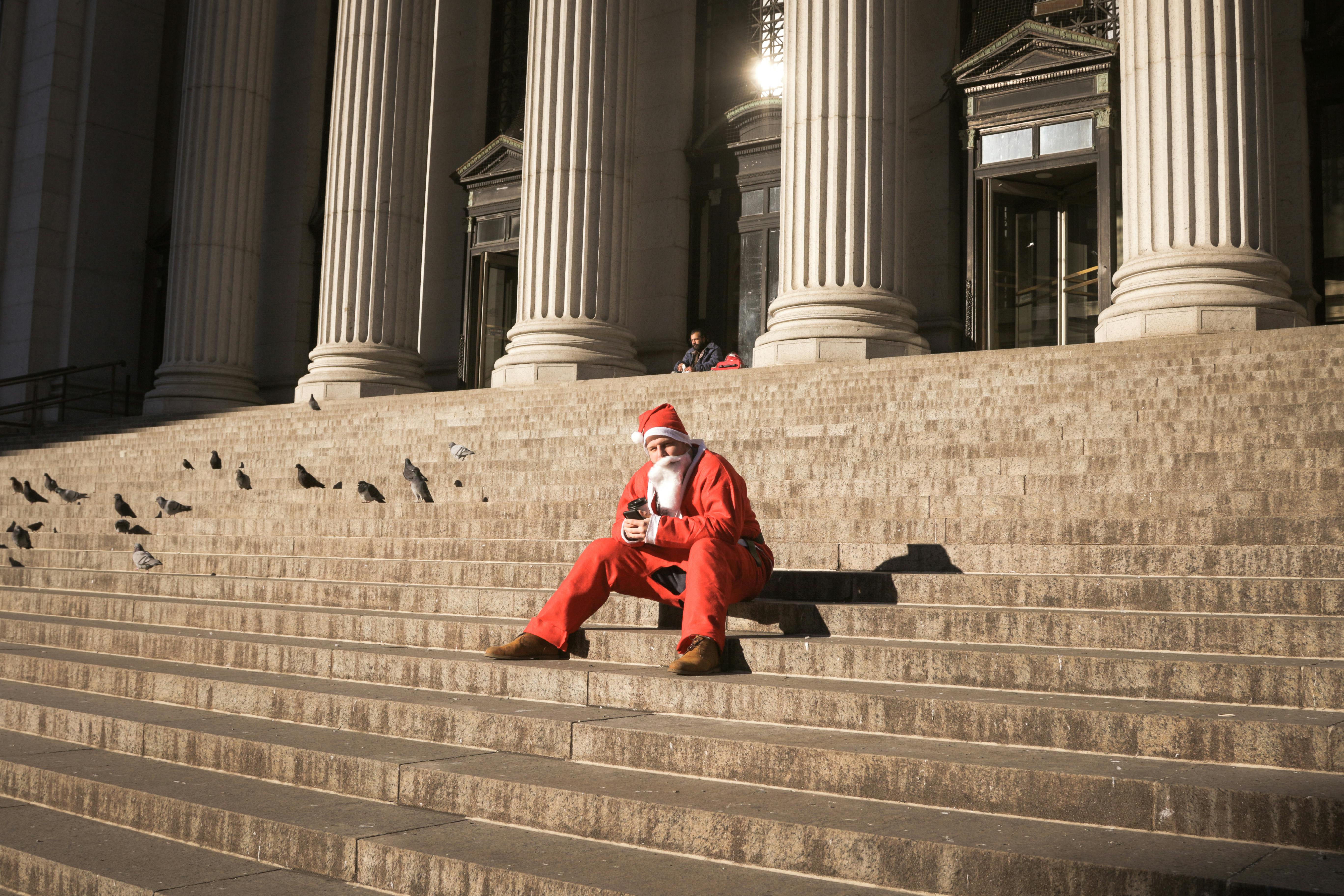Man in Santa Costume Sitting on Stairs · Free Stock Photo