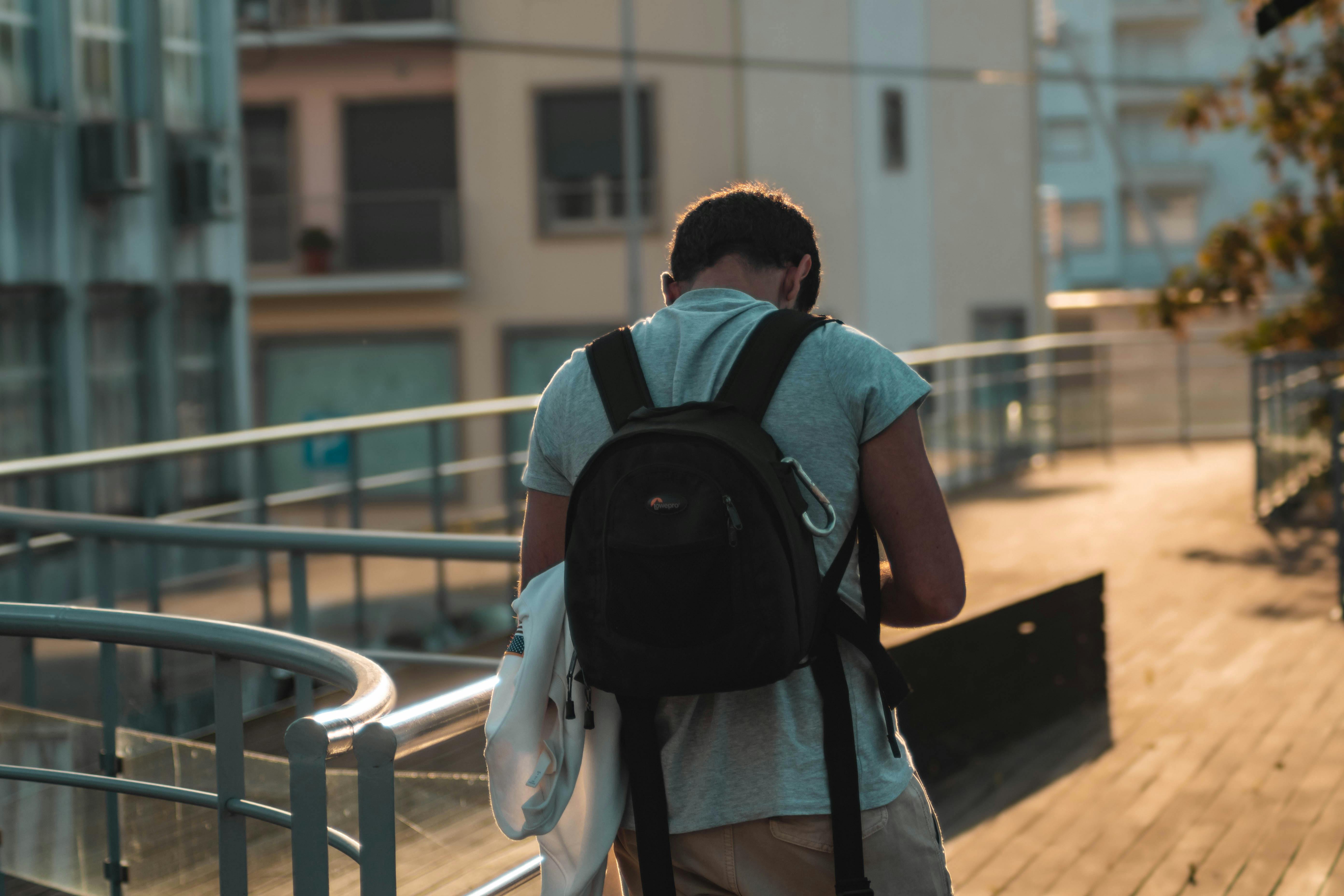 Man Walking on Sidewalk in Town · Free Stock Photo