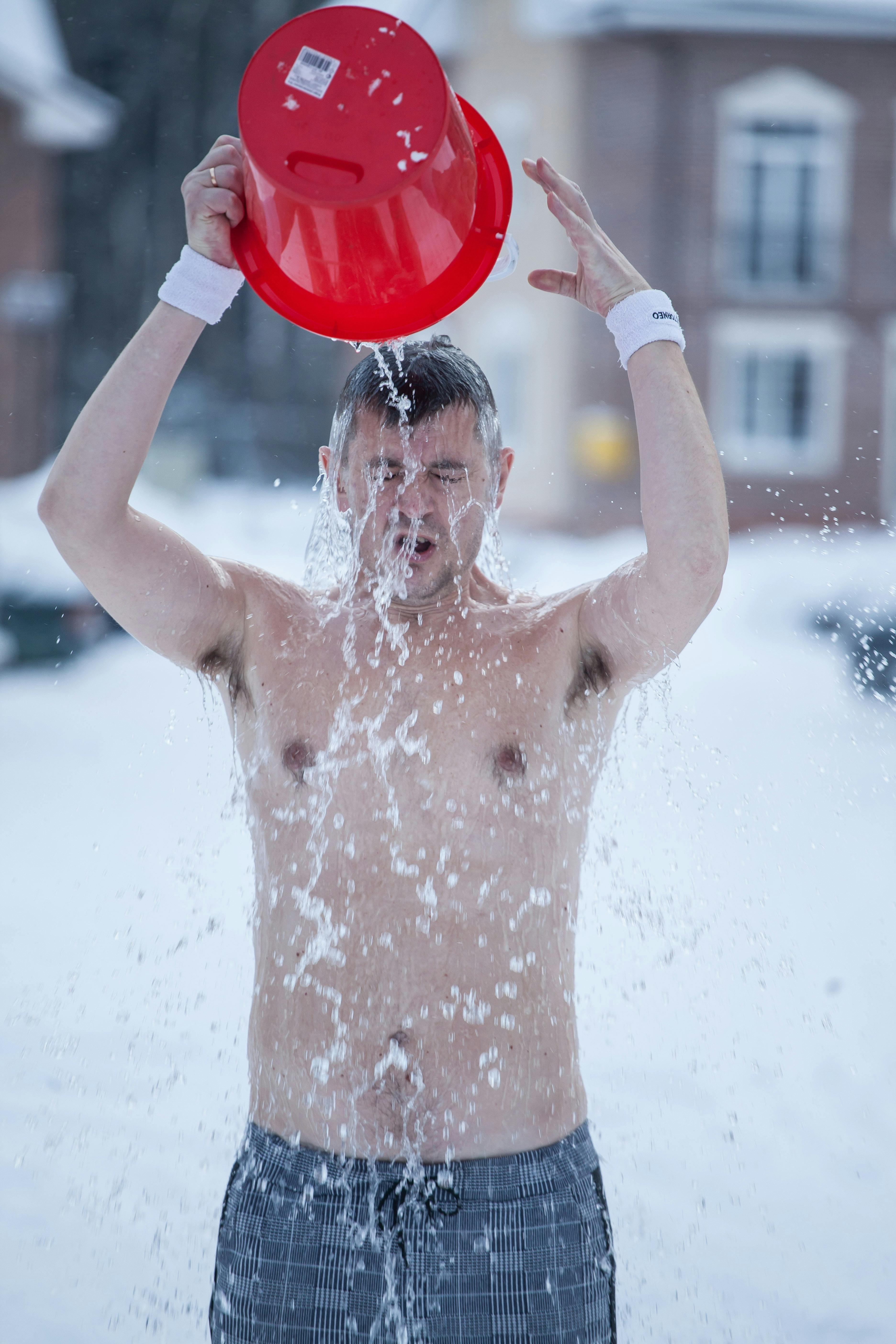 Topless Man Pouring Water on Body in Winter · Free Stock Photo