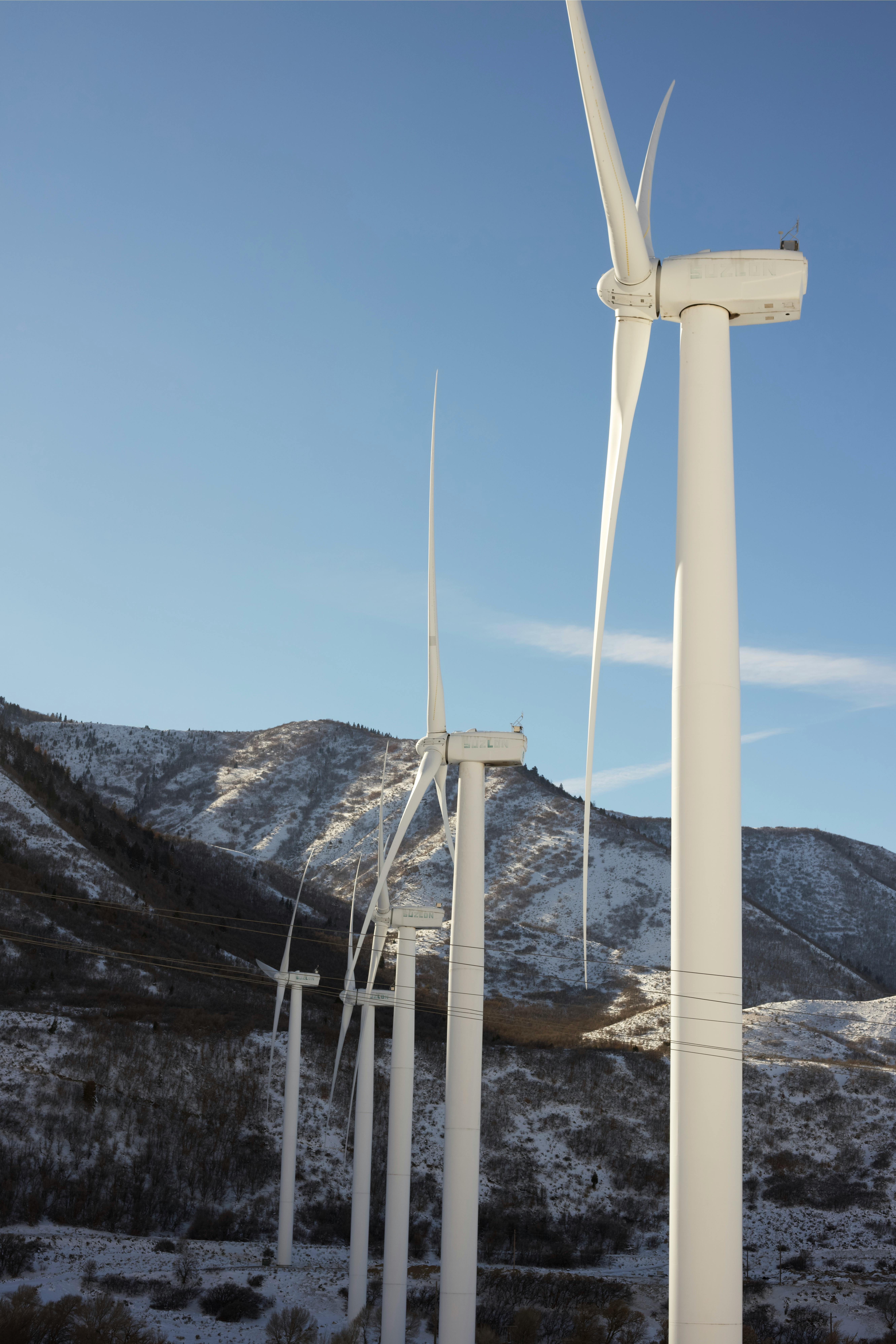White Wind Turbines Near the Rock Mountains · Free Stock Photo
