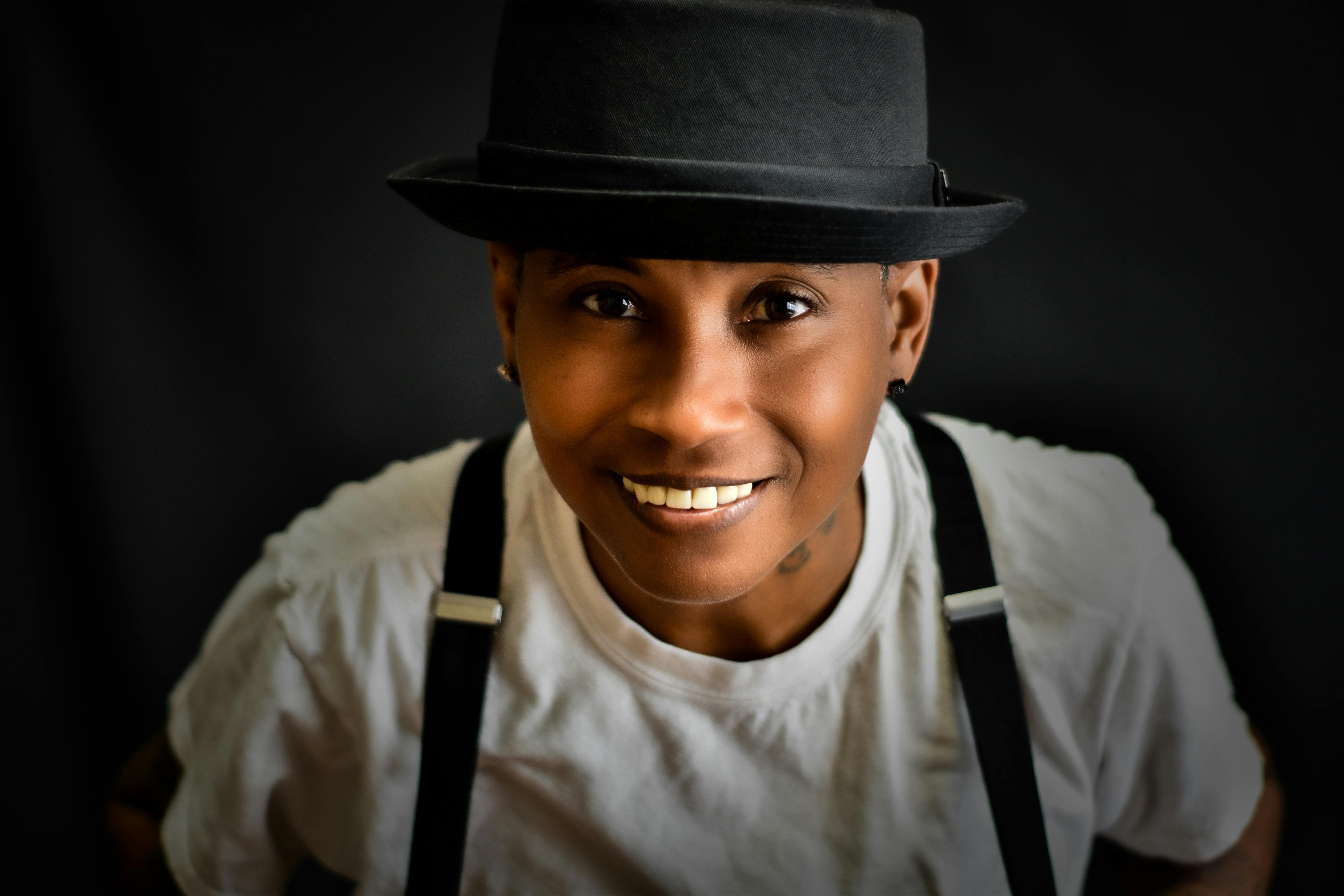 Close-Up Shot of a Person Wearing Black Fedora Hat · Free Stock Photo