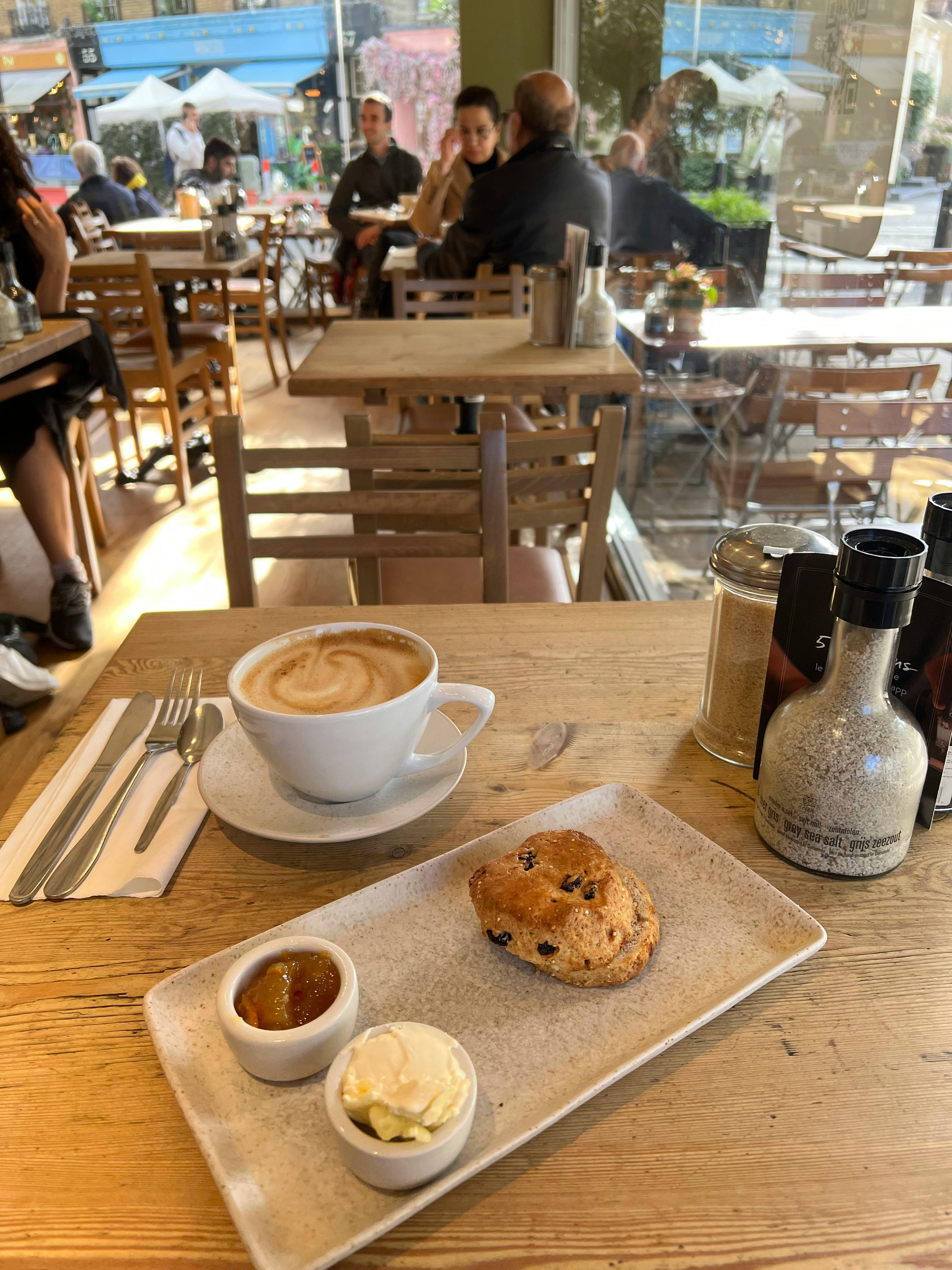 Exterior of stylish coffee shop with glass wall and street terrace ...
