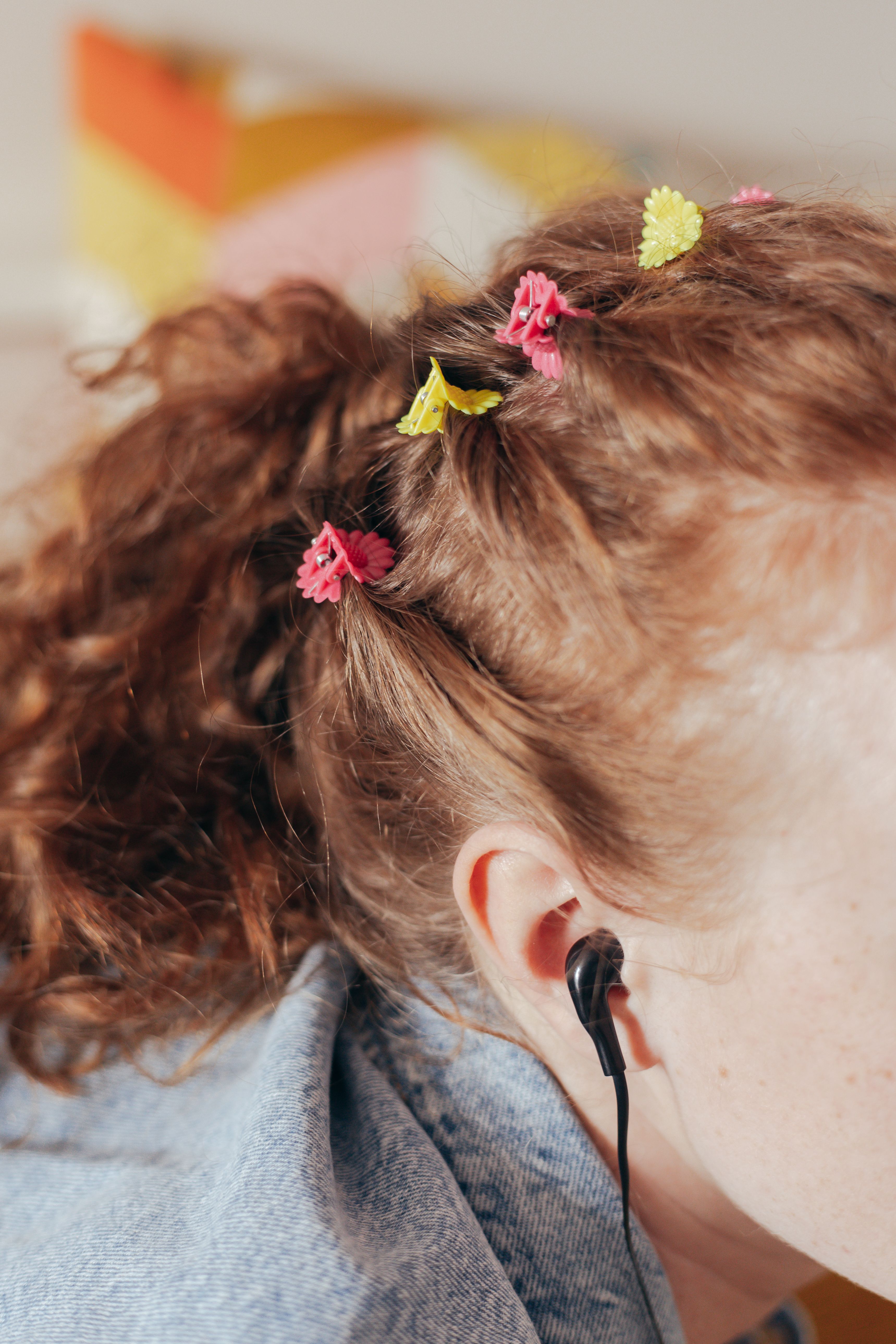 A Woman Wearing Hair Clips Listening to Music · Free Stock Photo