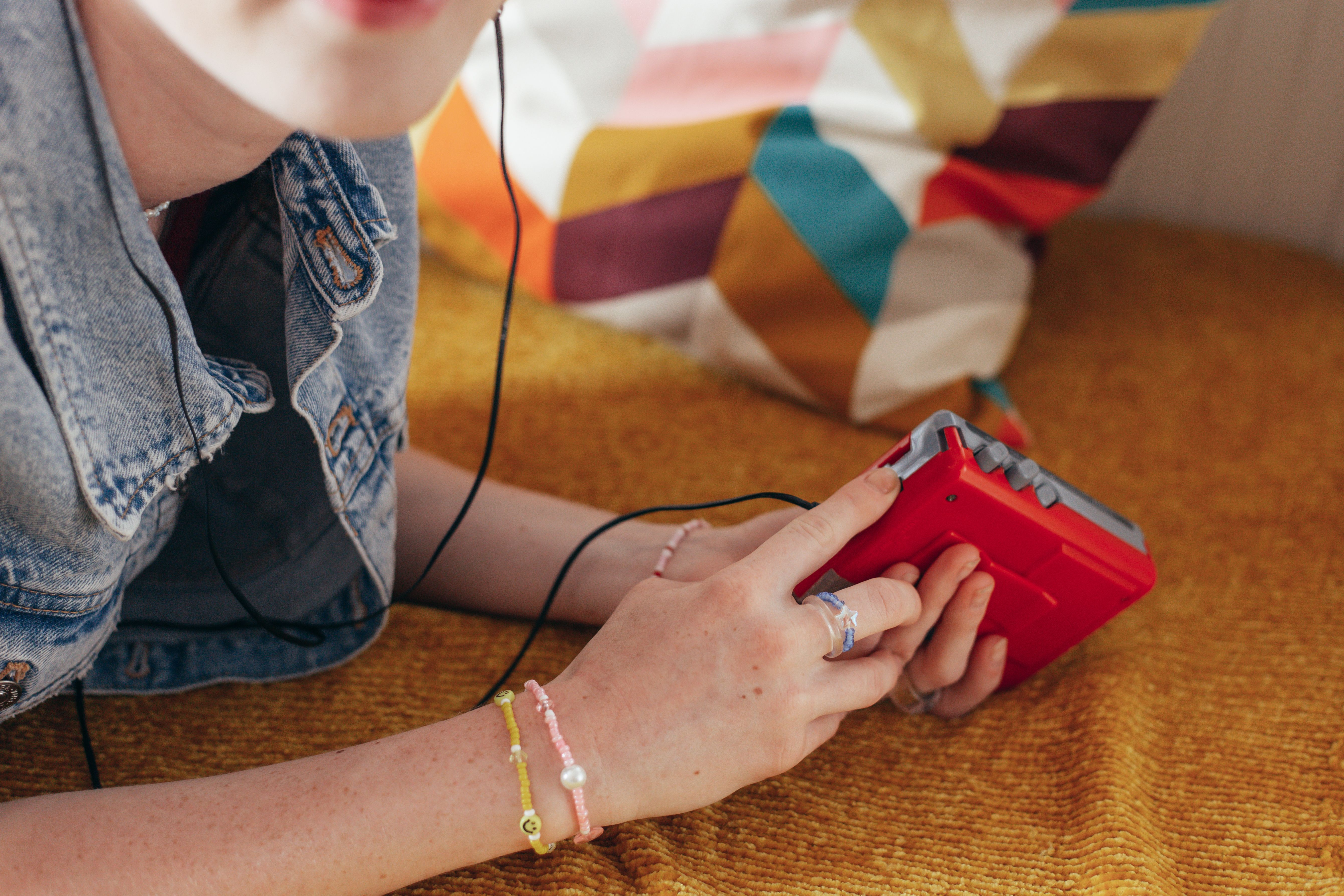 Close-up of a Girl Lying on a Bed and Listening to Music on a Walkman ...