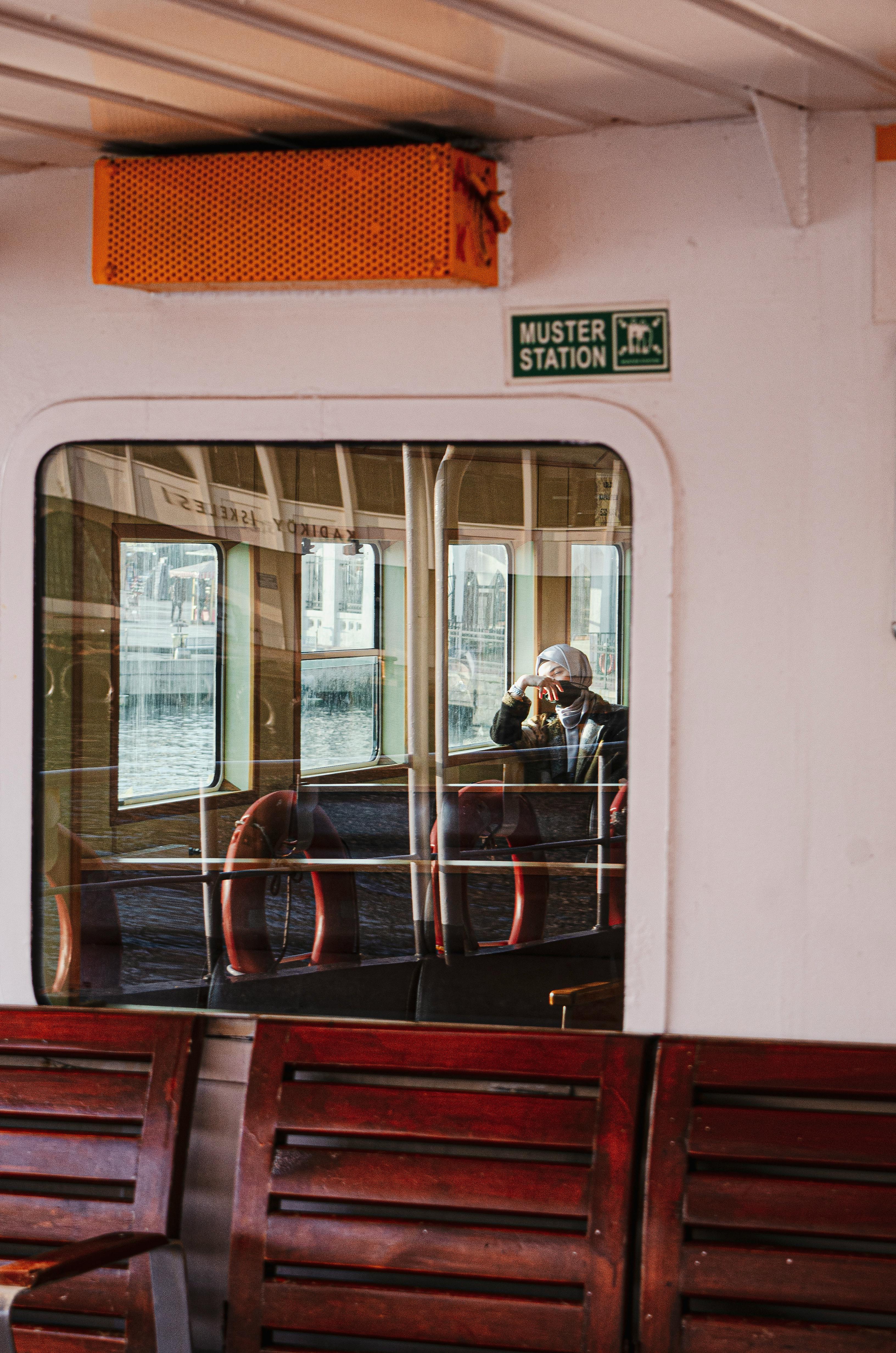 A Reflection of a Person Traveling in a Ferry · Free Stock Photo