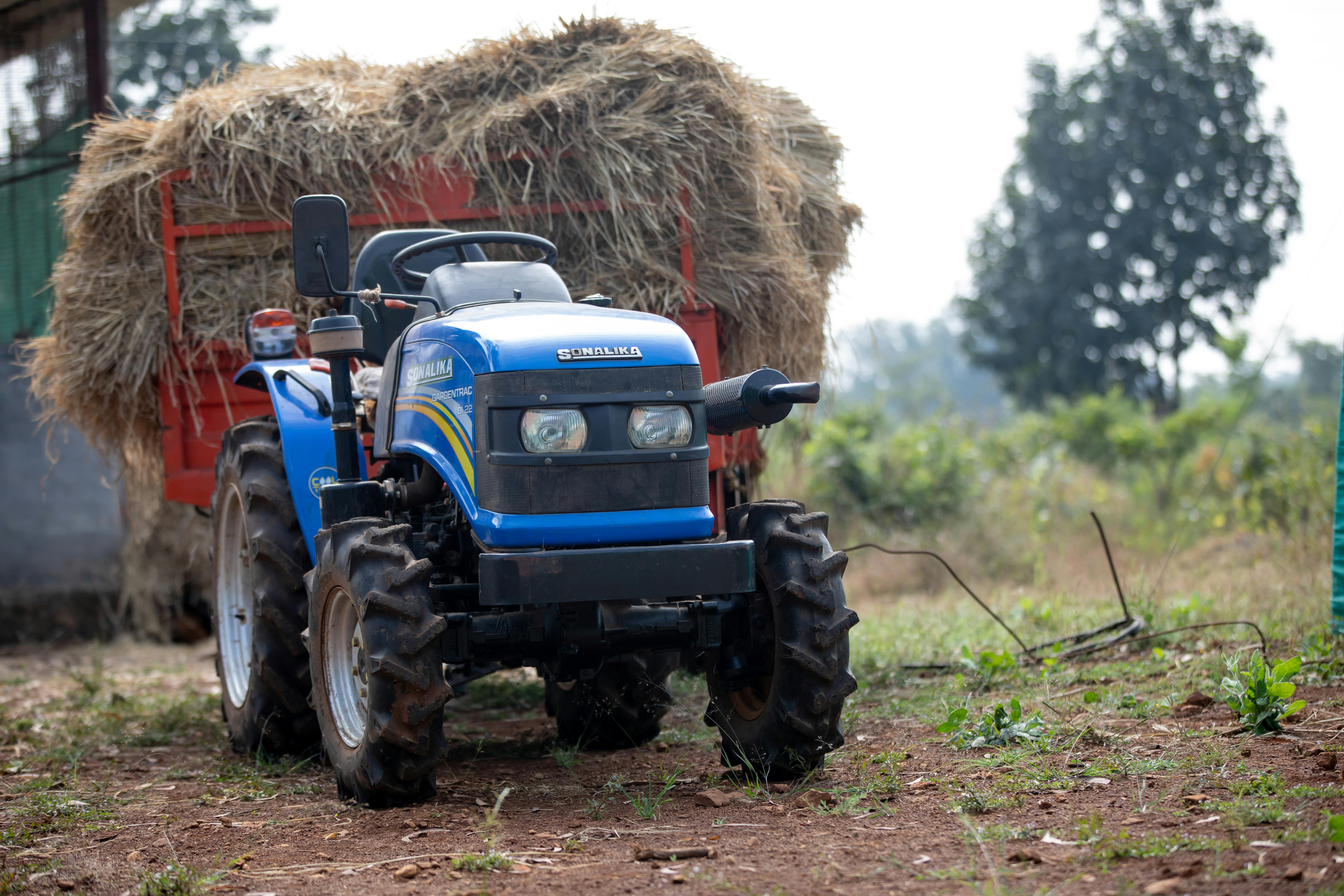 A Couple Standing by a Tractor · Free Stock Photo