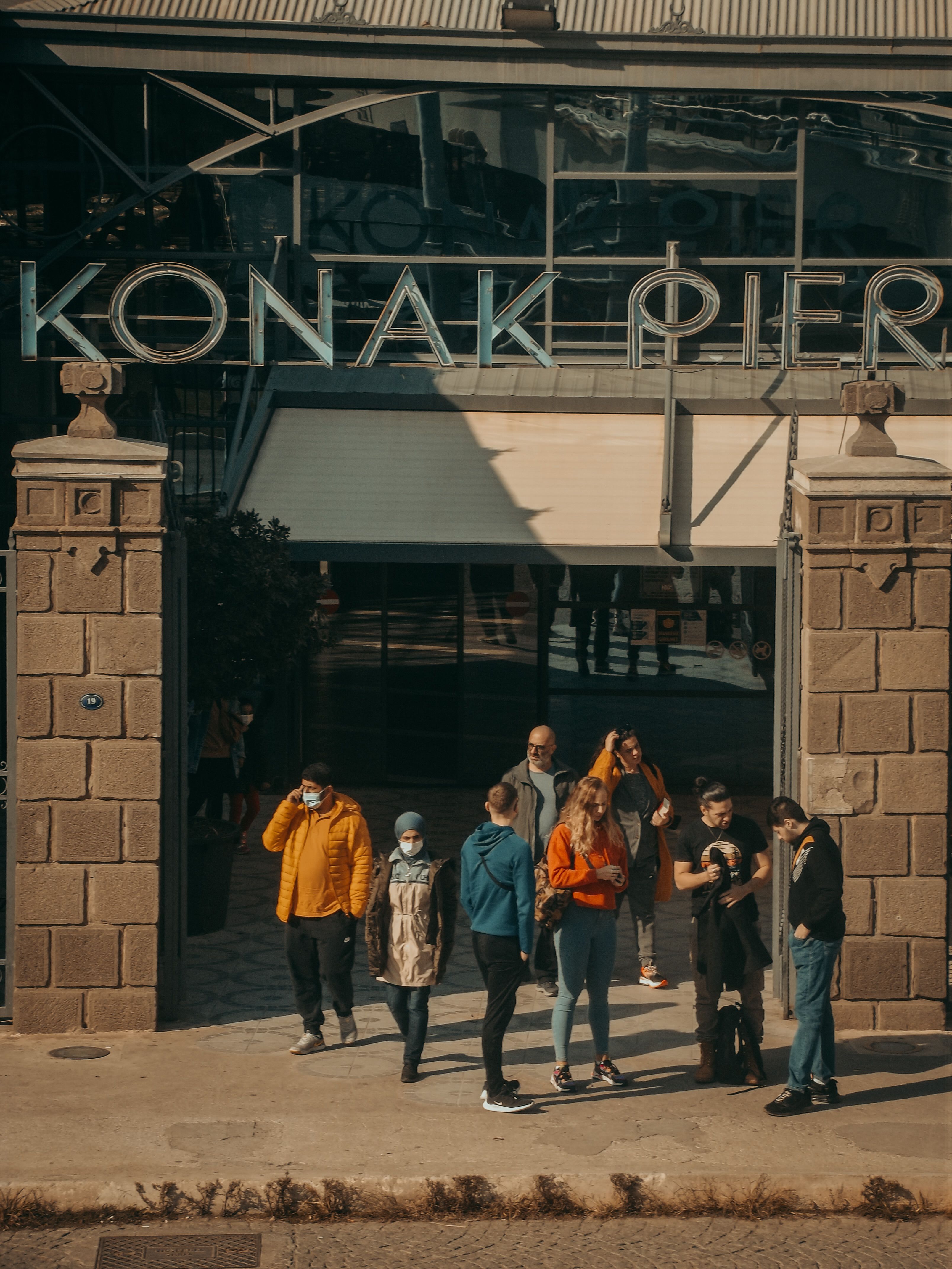 People Standing Outside the Concrete Building · Free Stock Photo