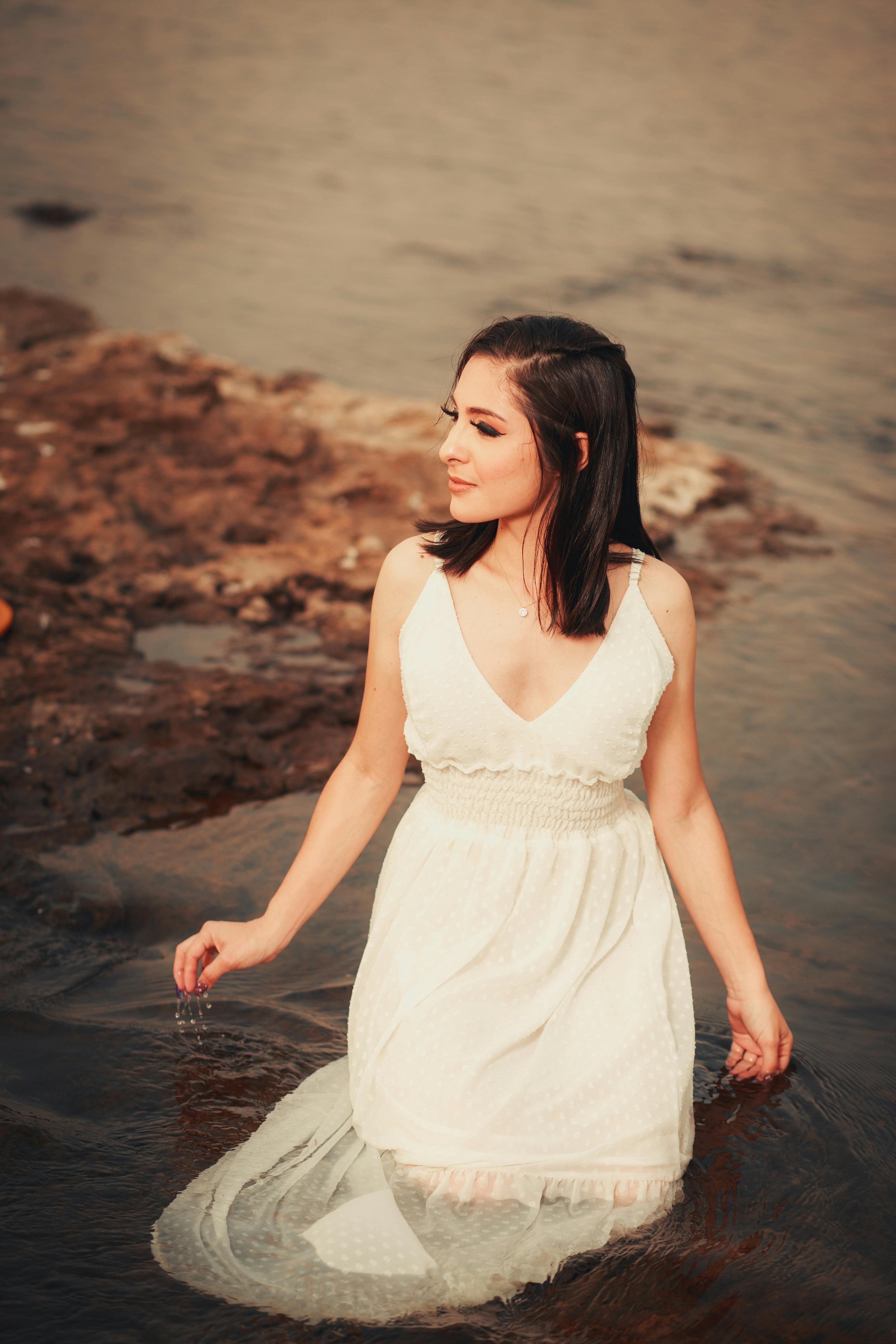 A Woman Wearing White Dress Standing on the Water · Free Stock Photo