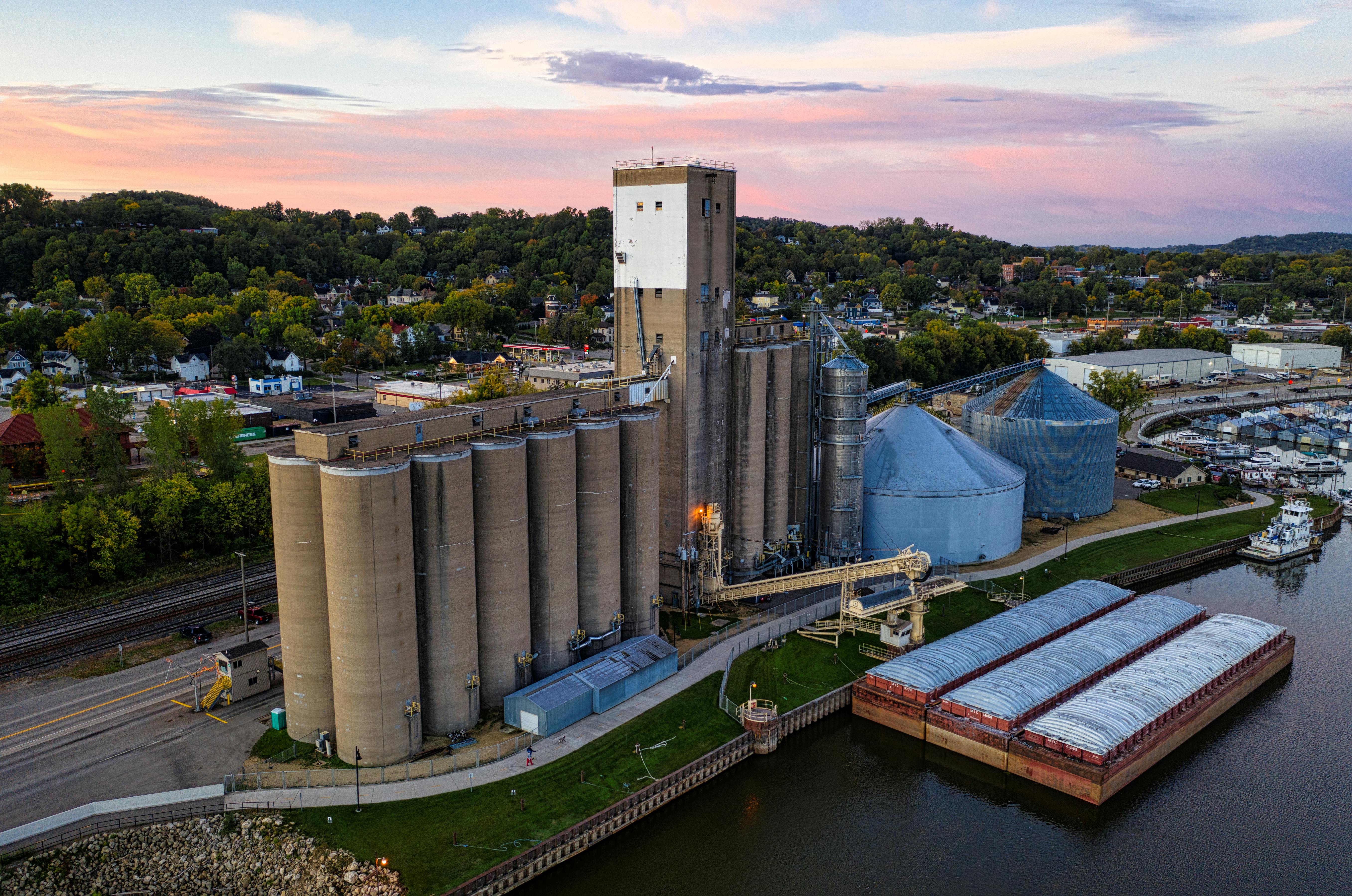 Aerial View of an Industry with Grain Elevators near a Reservoir · Free ...