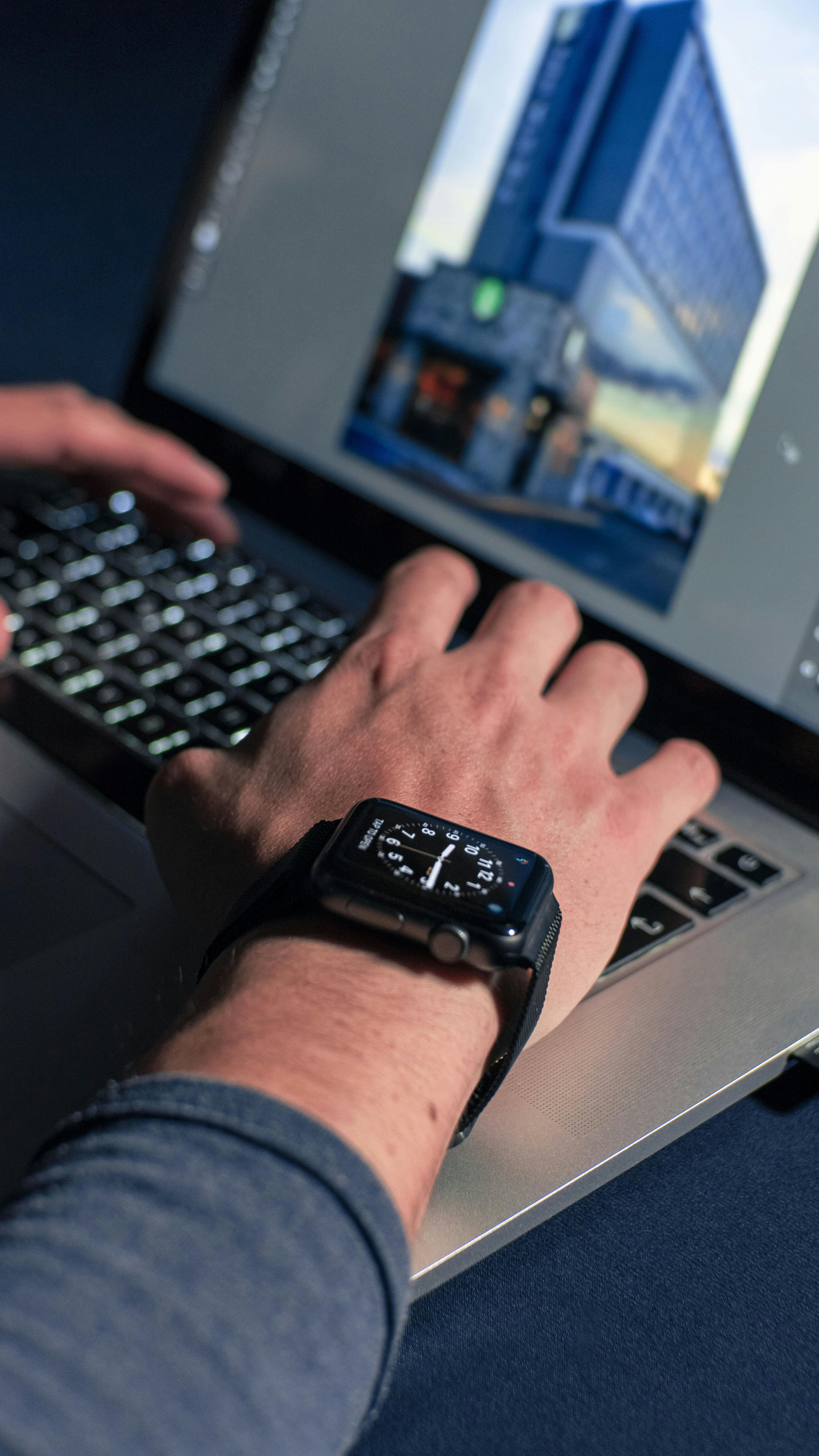 A Person Wearing Apple Watch while Typing · Free Stock Photo