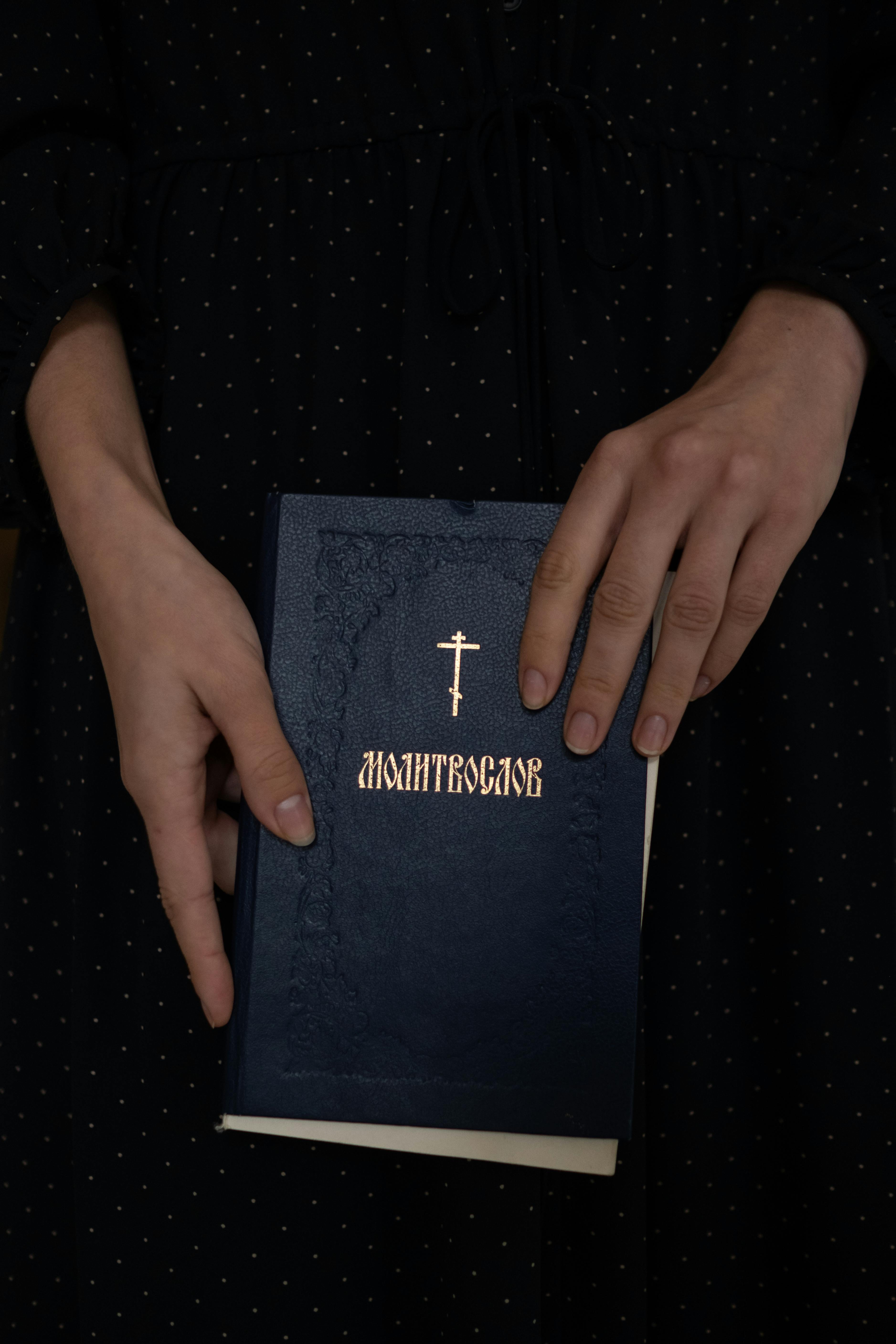 Prayer Book Held in Hands · Free Stock Photo