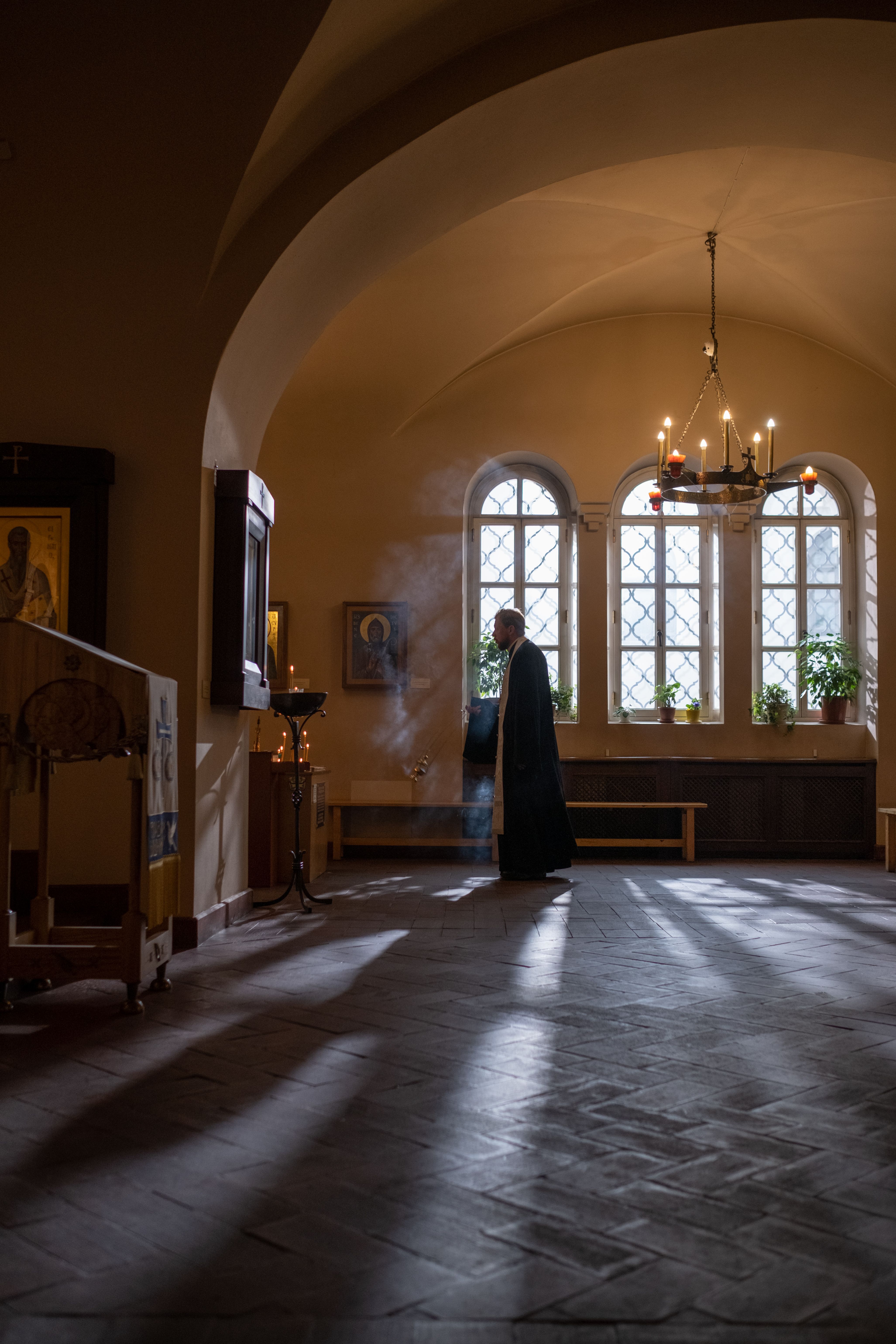 Priest Standing near Windows at Orthodox Church · Free Stock Photo