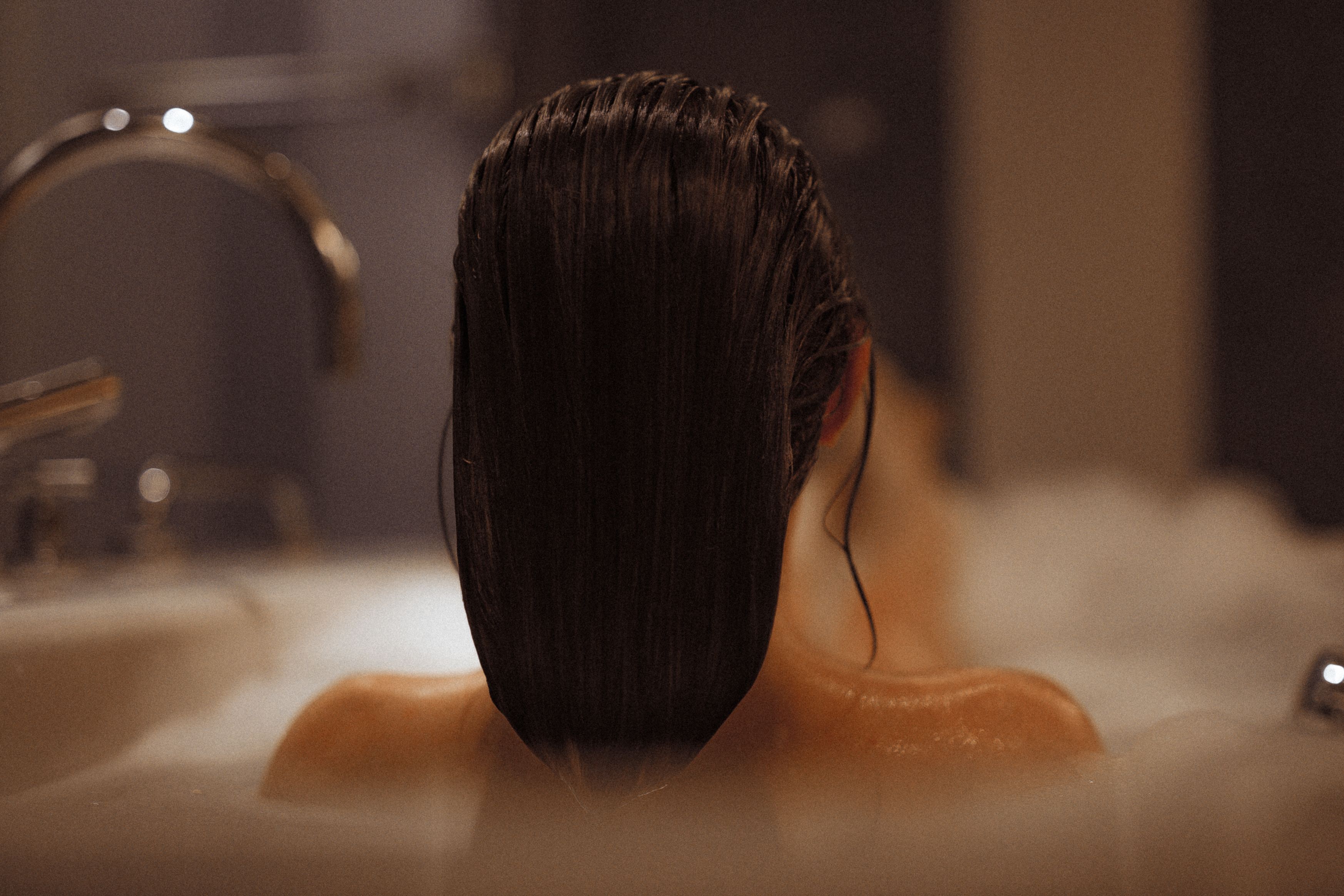 Back View of a Person in a Bathtub · Free Stock Photo