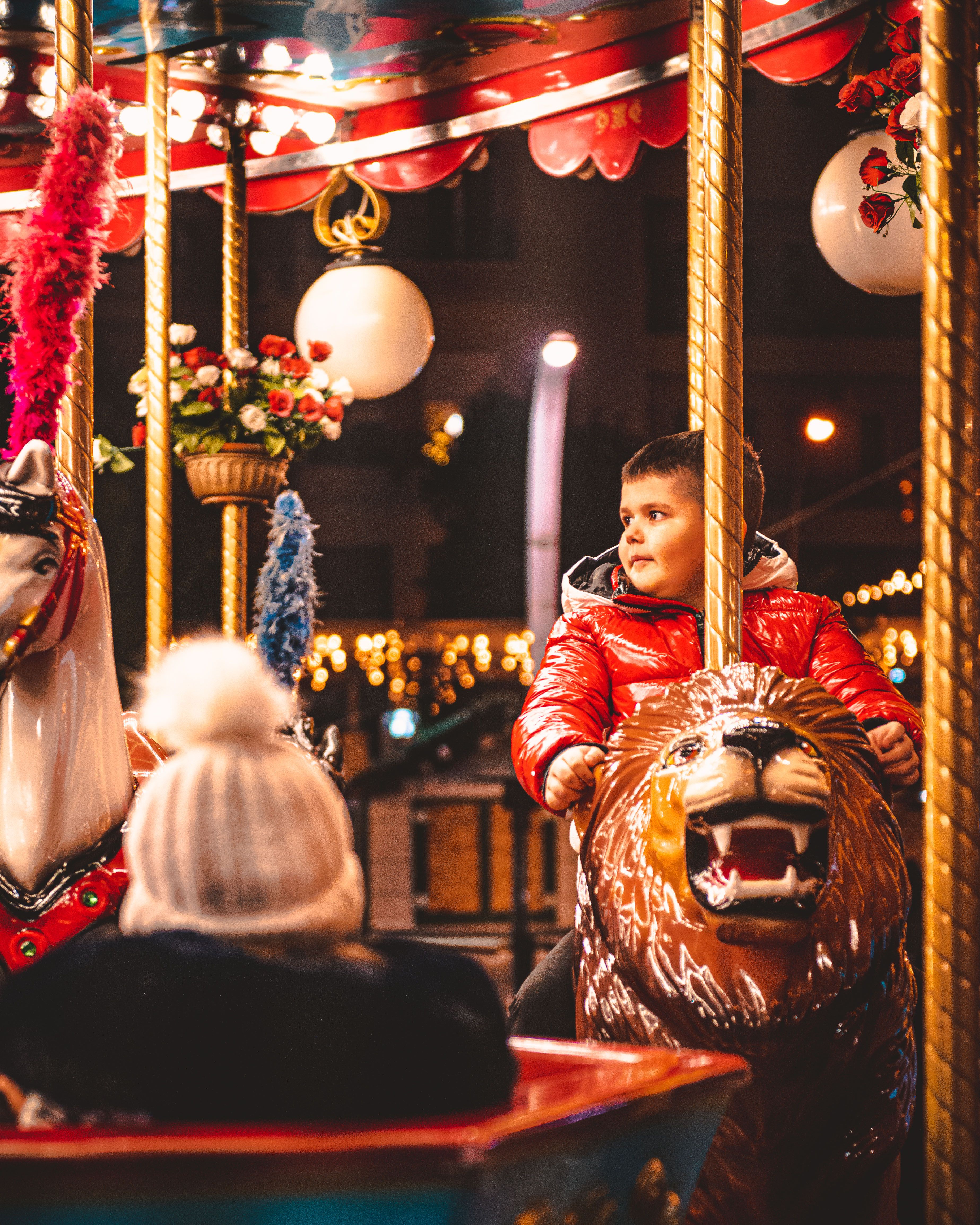 A Boy Riding a Carousel · Free Stock Photo