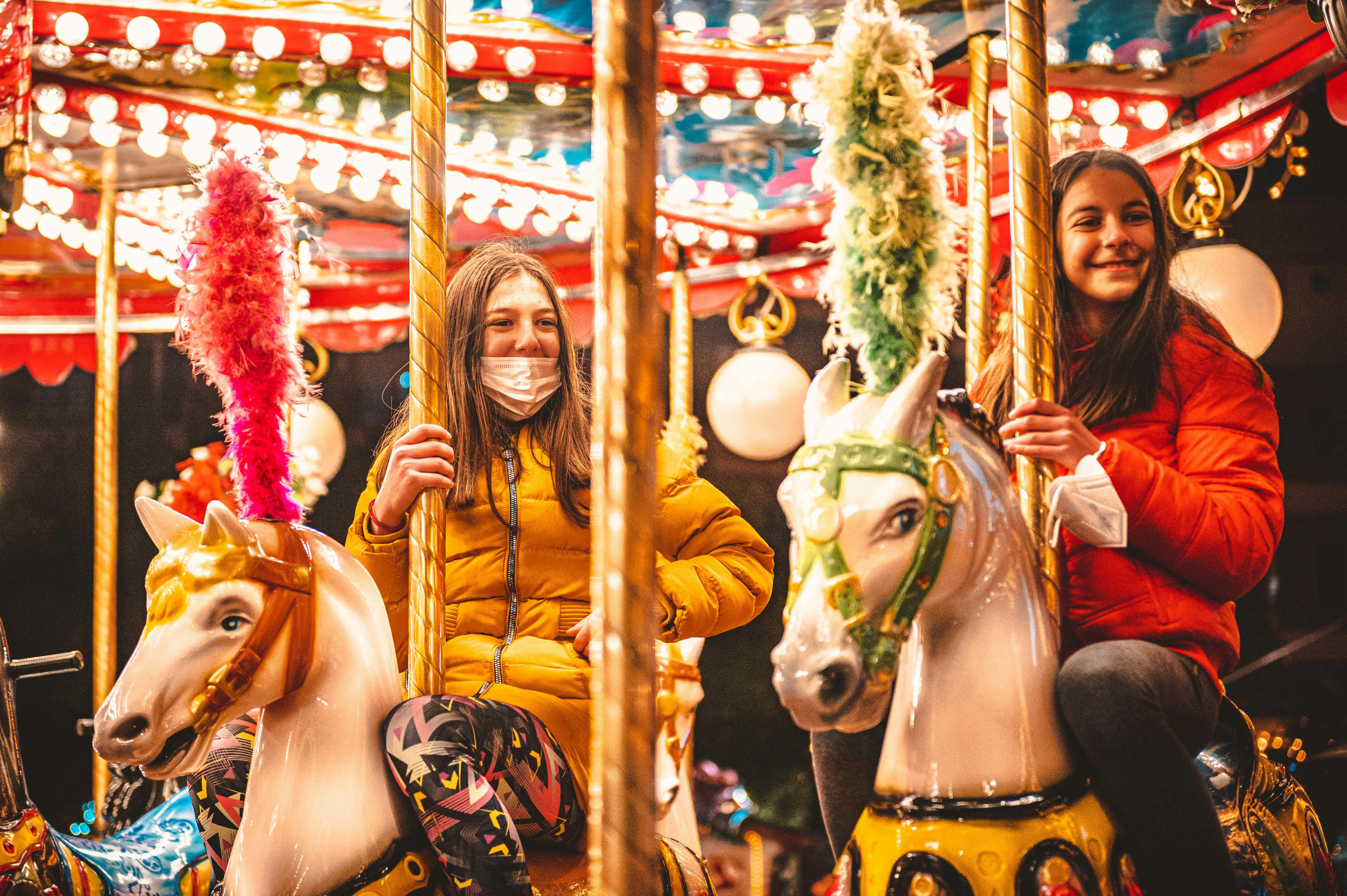 Two Girls Riding a Carousel · Free Stock Photo