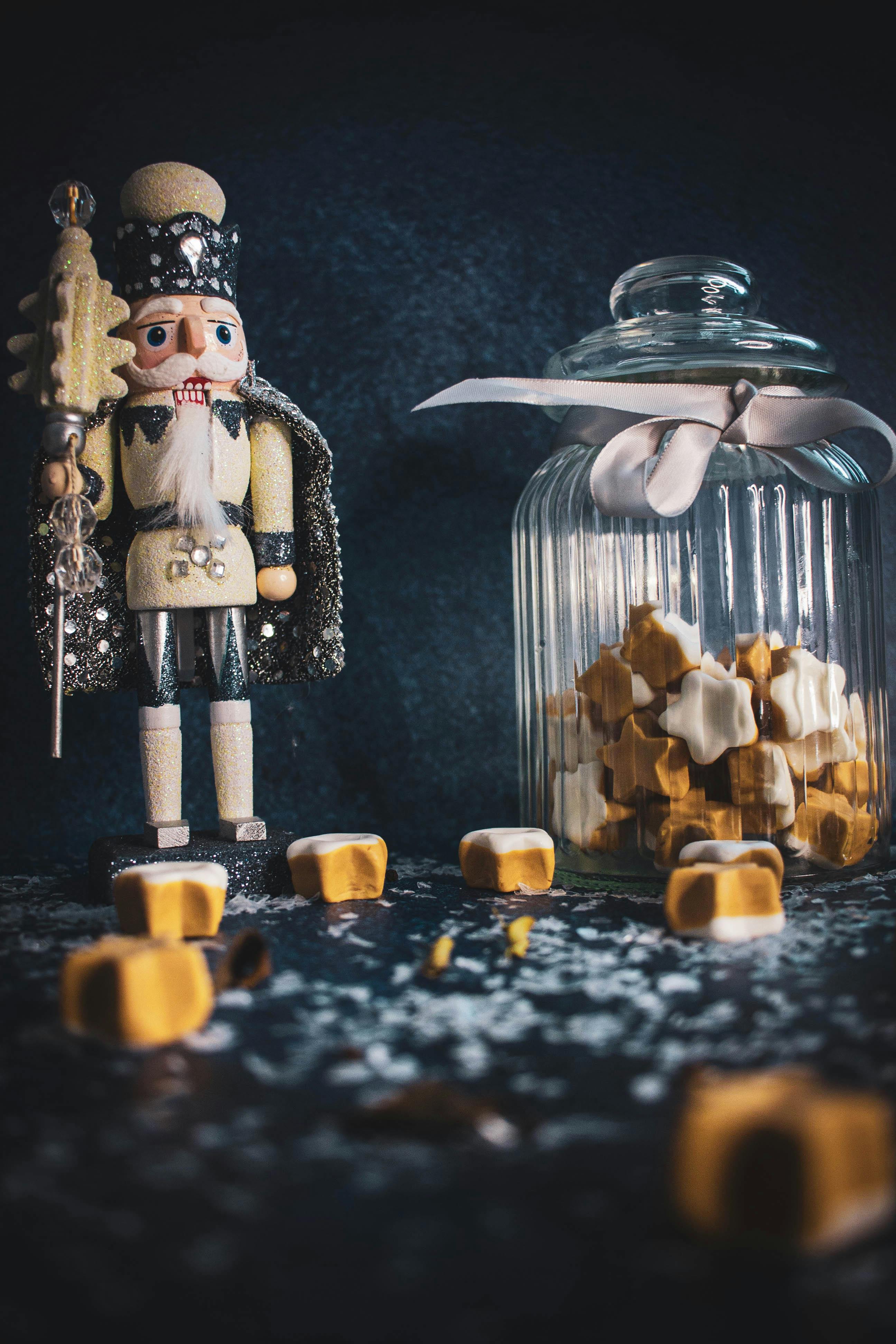 Nutcracker beside a Glass Container of Candies · Free Stock Photo