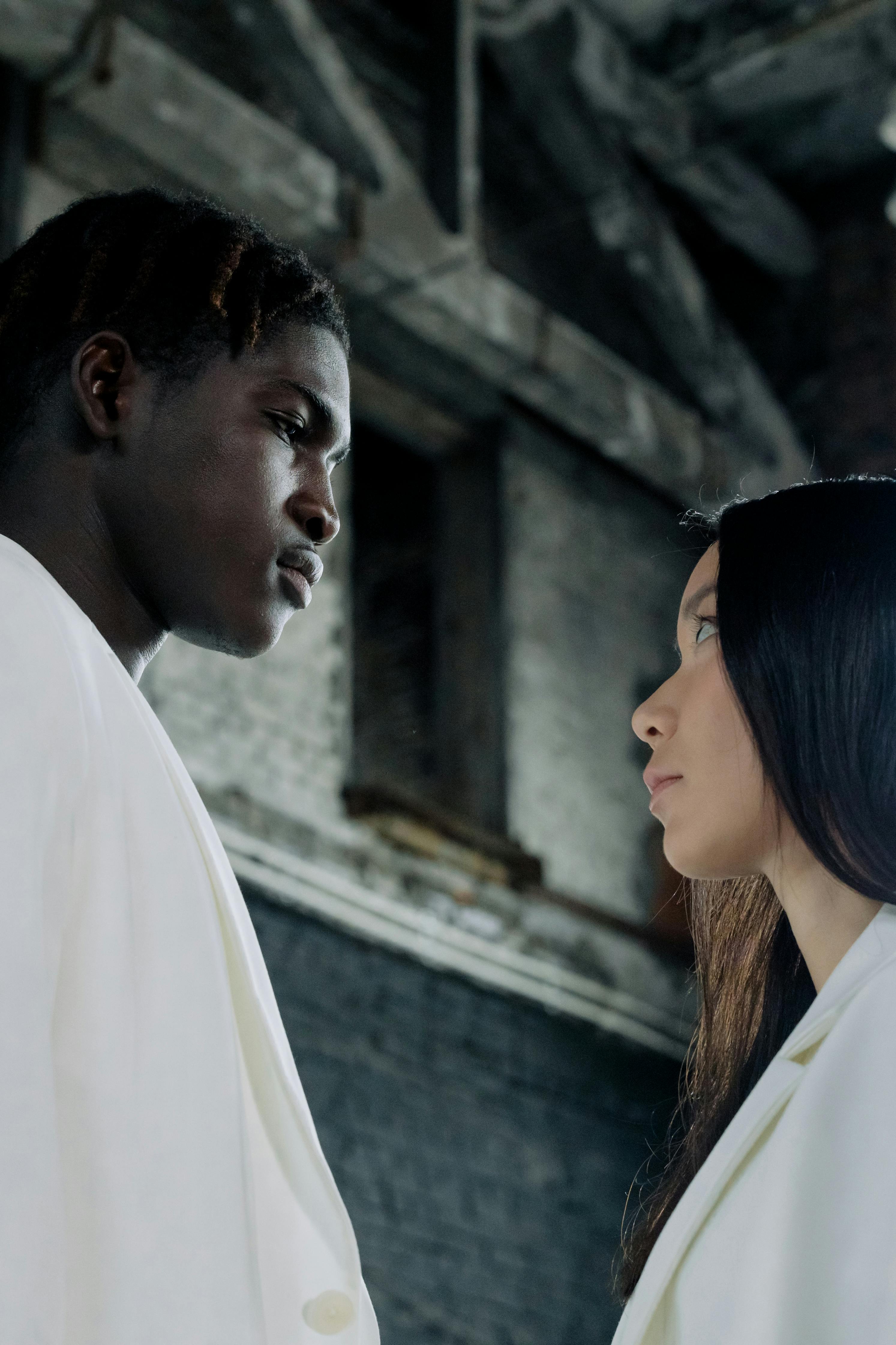 Low Angle Shot of Two People looking at each other · Free Stock Photo