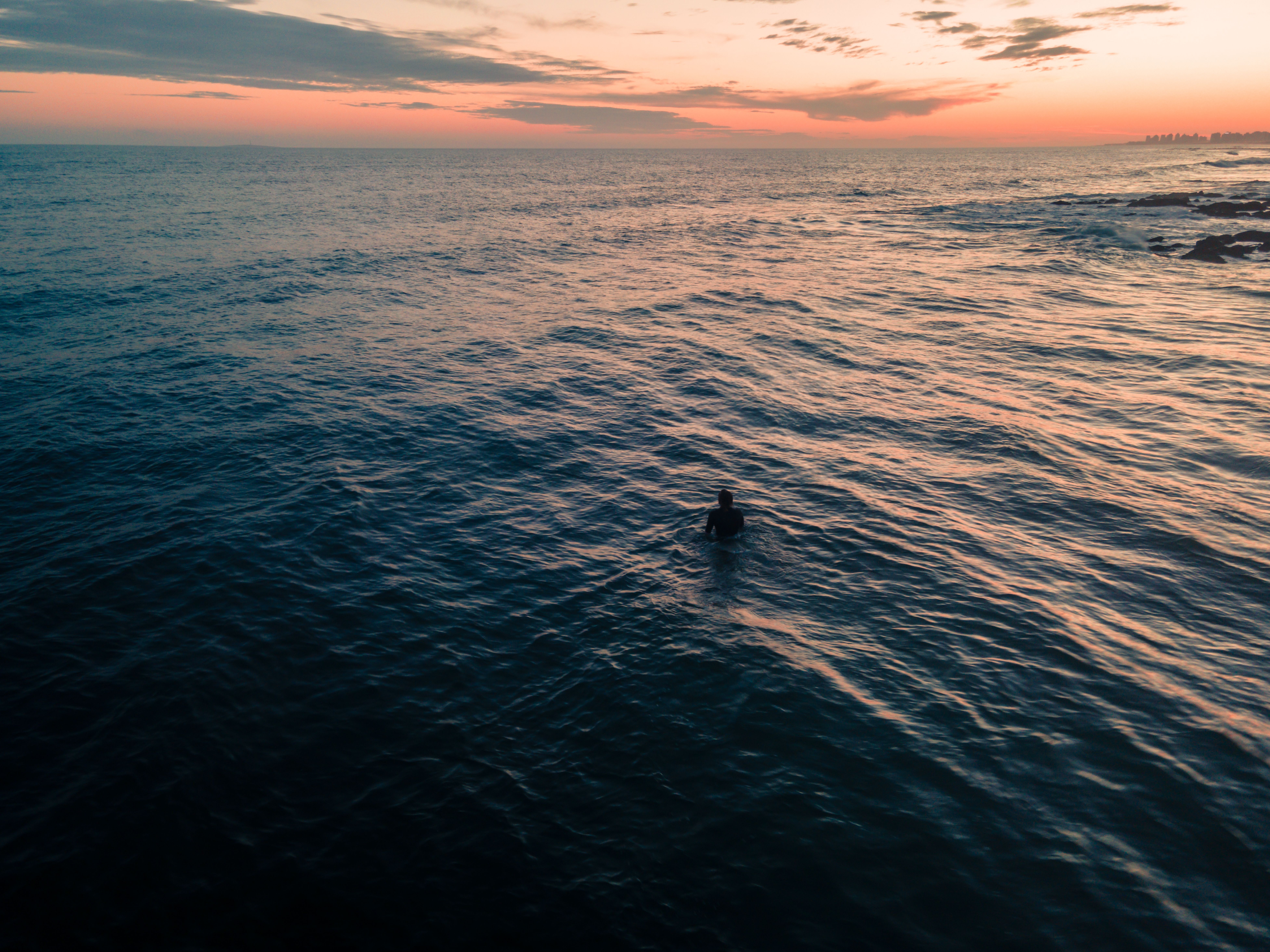 Photo of a Person in the Sea during Sunset · Free Stock Photo