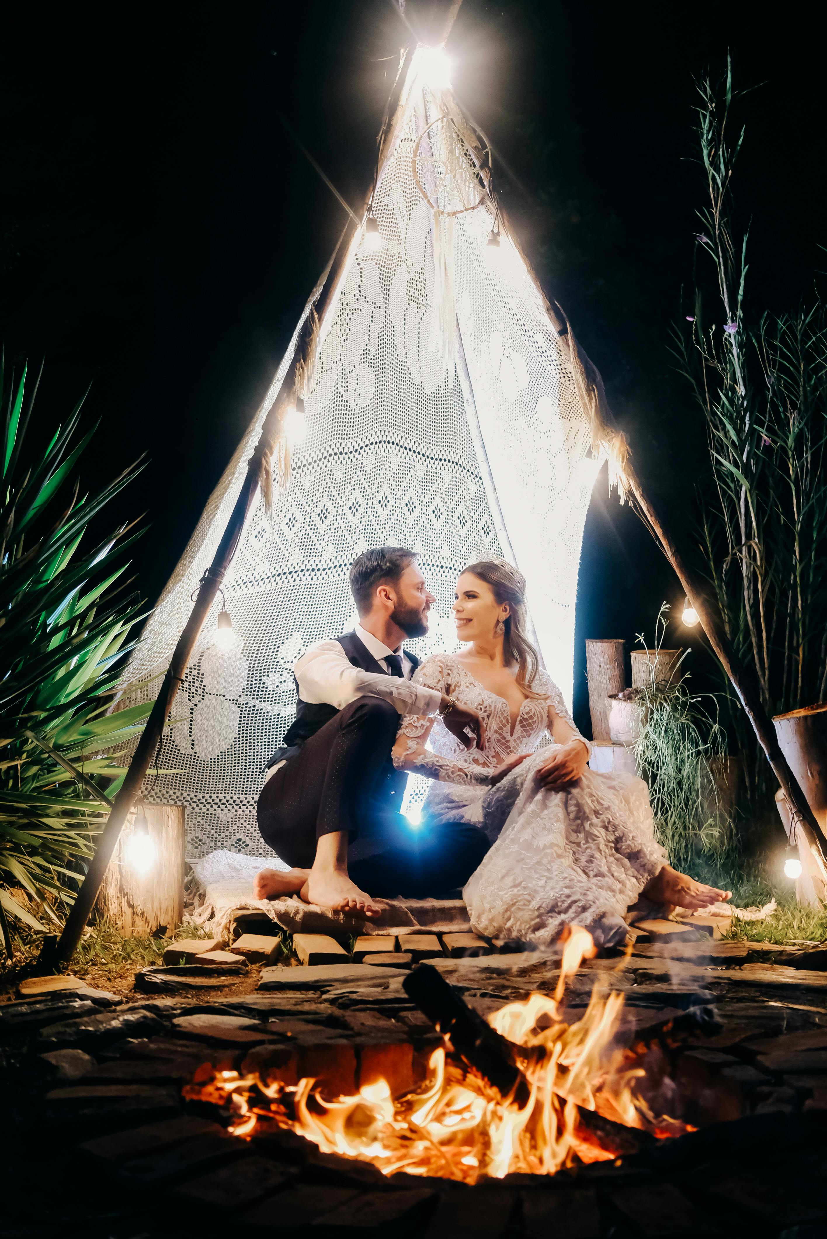 Couple SItting Beside Teepee · Free Stock Photo