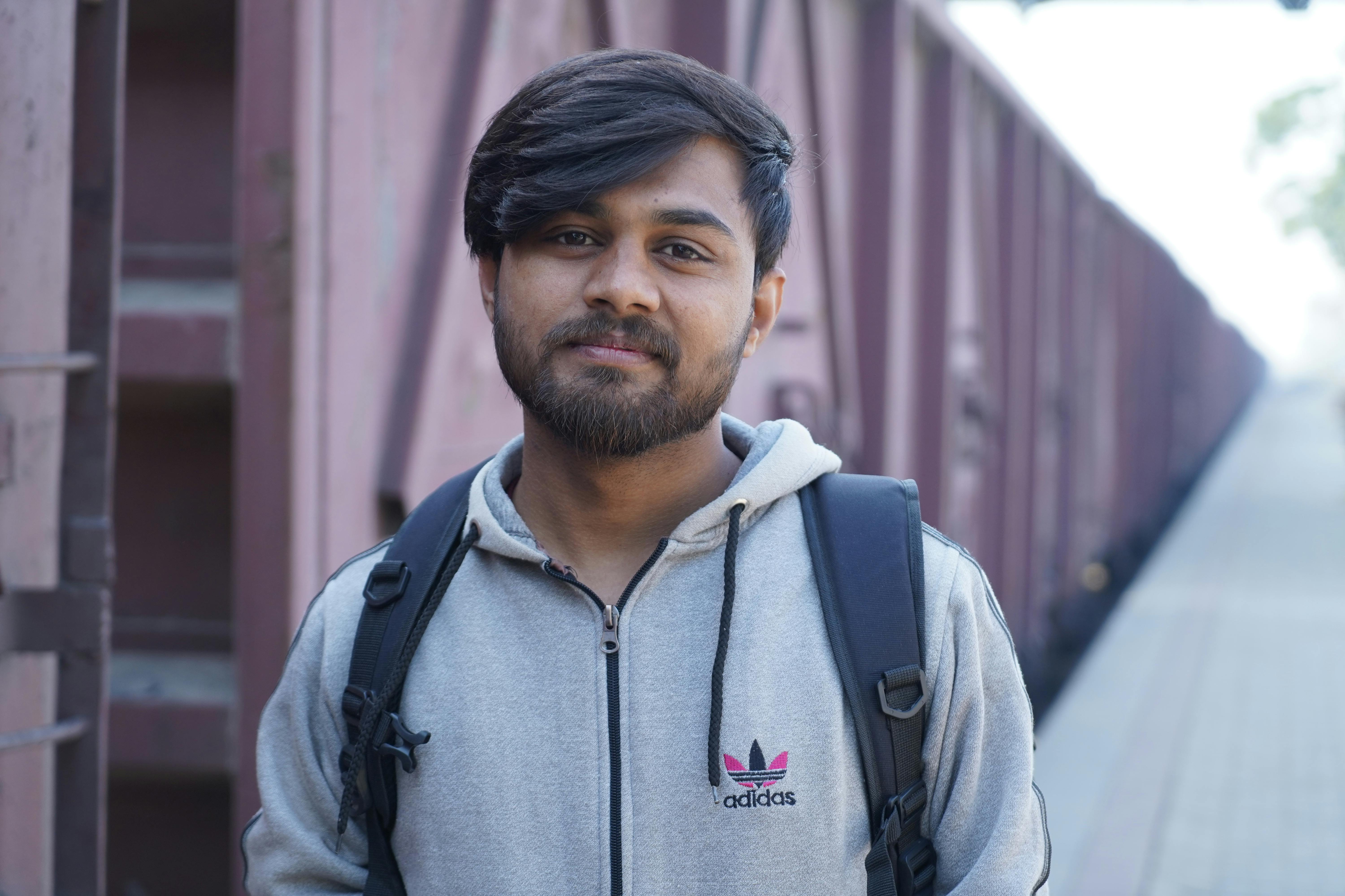 A Man Smiling while Looking Down · Free Stock Photo