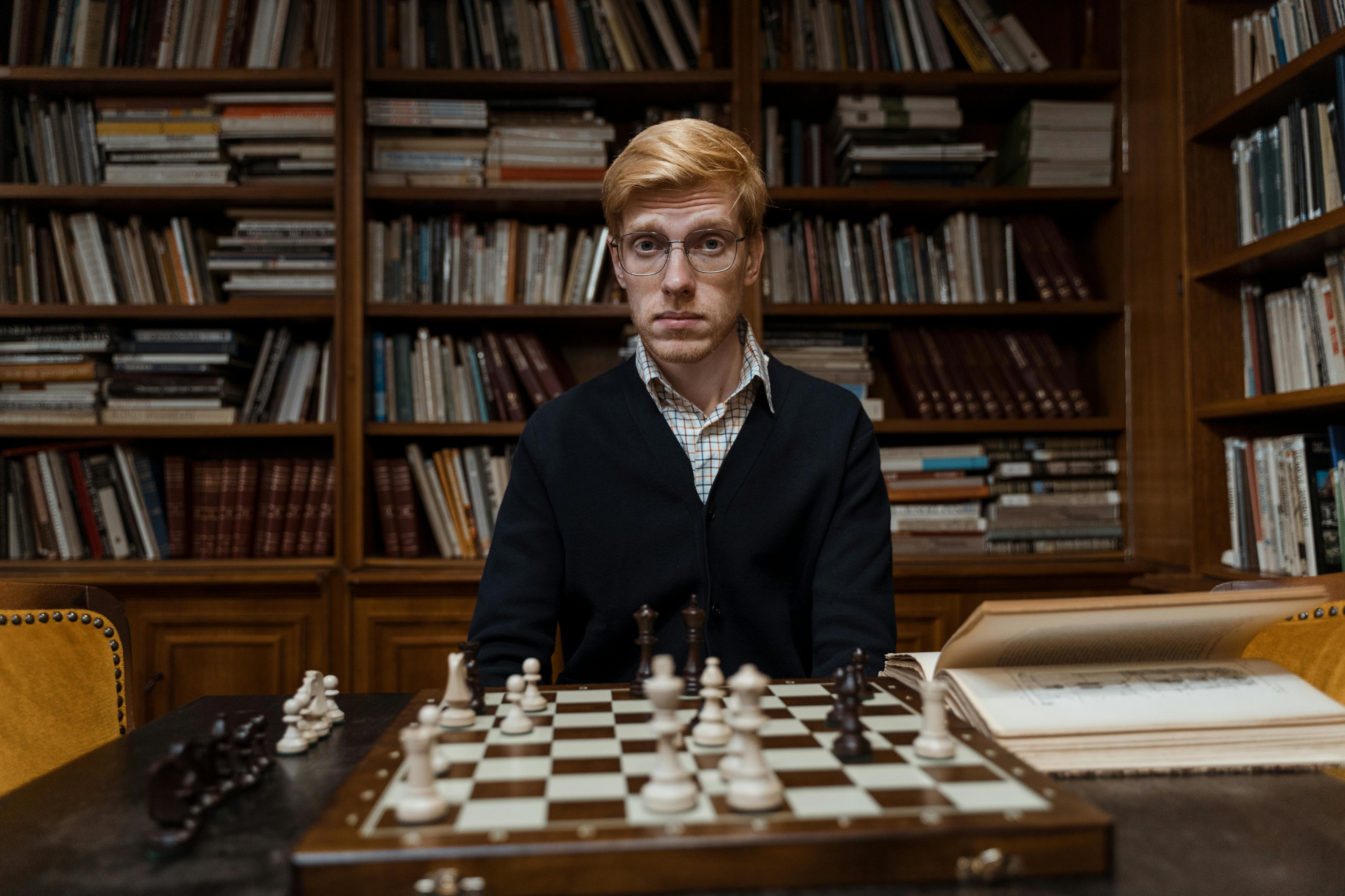 Man sitting in front of a Chess Board · Free Stock Photo