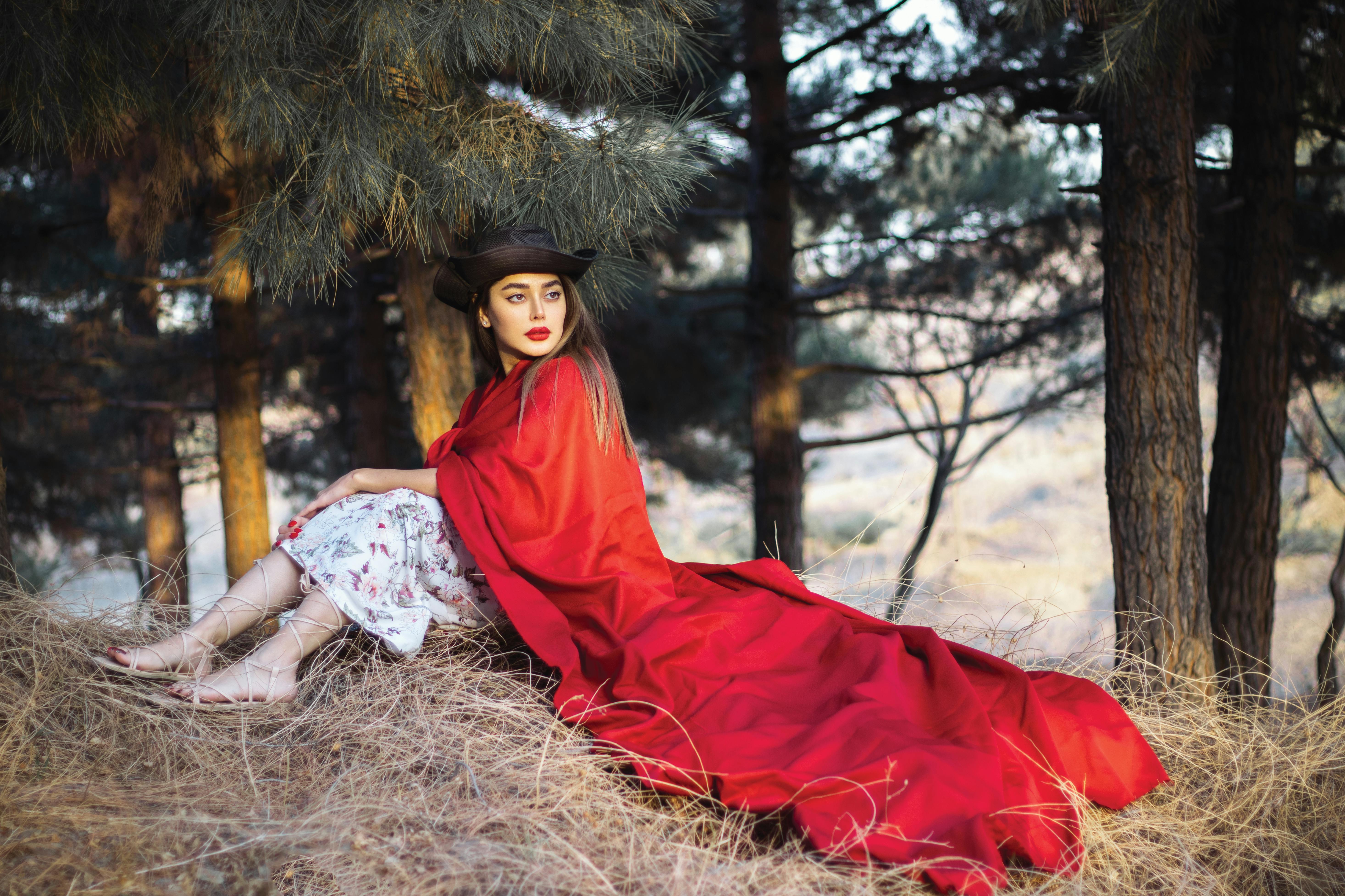 Woman Wearing Red Cape Sititng on Dry Grass · Free Stock Photo
