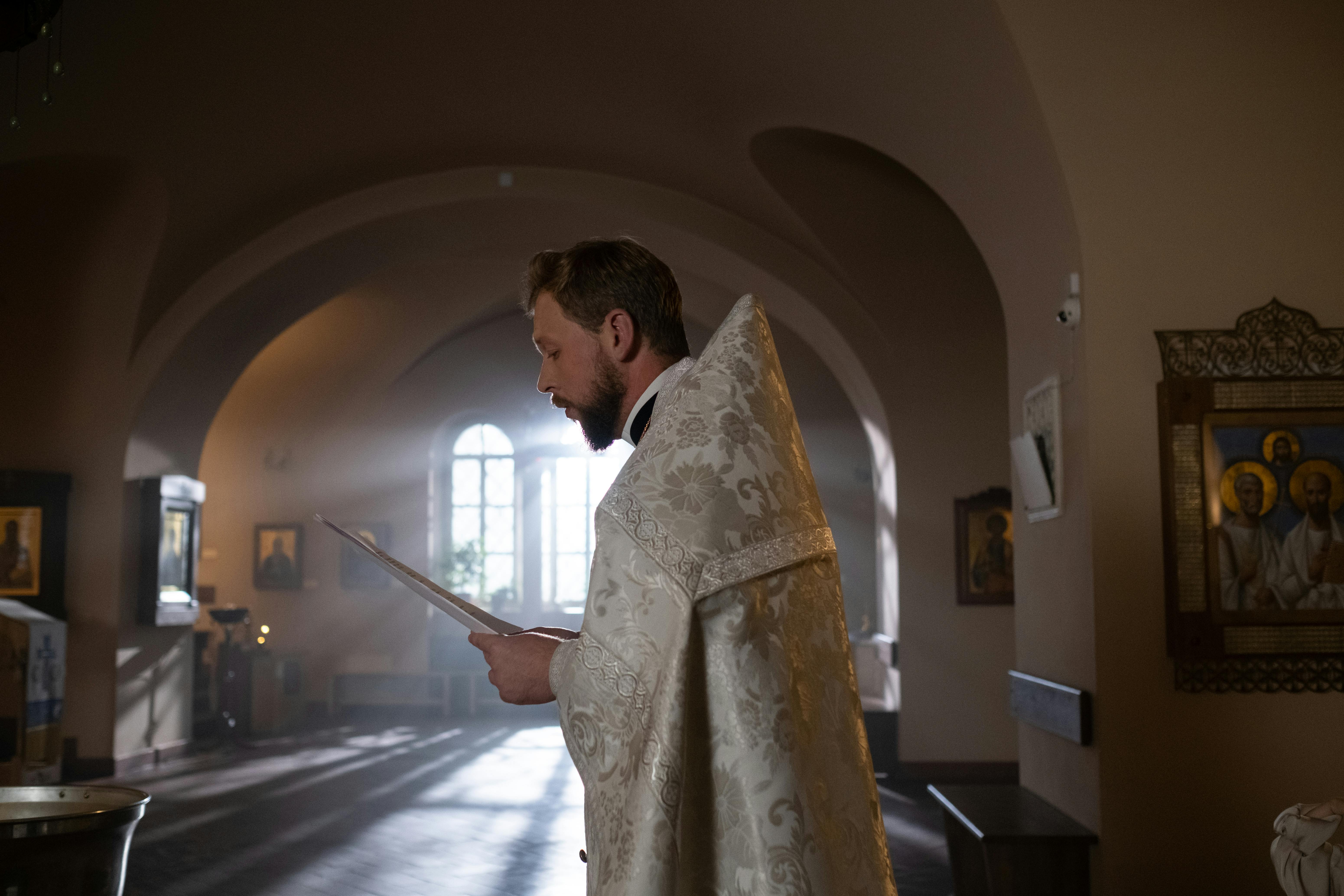 Priest reading a Holy Testament · Free Stock Photo