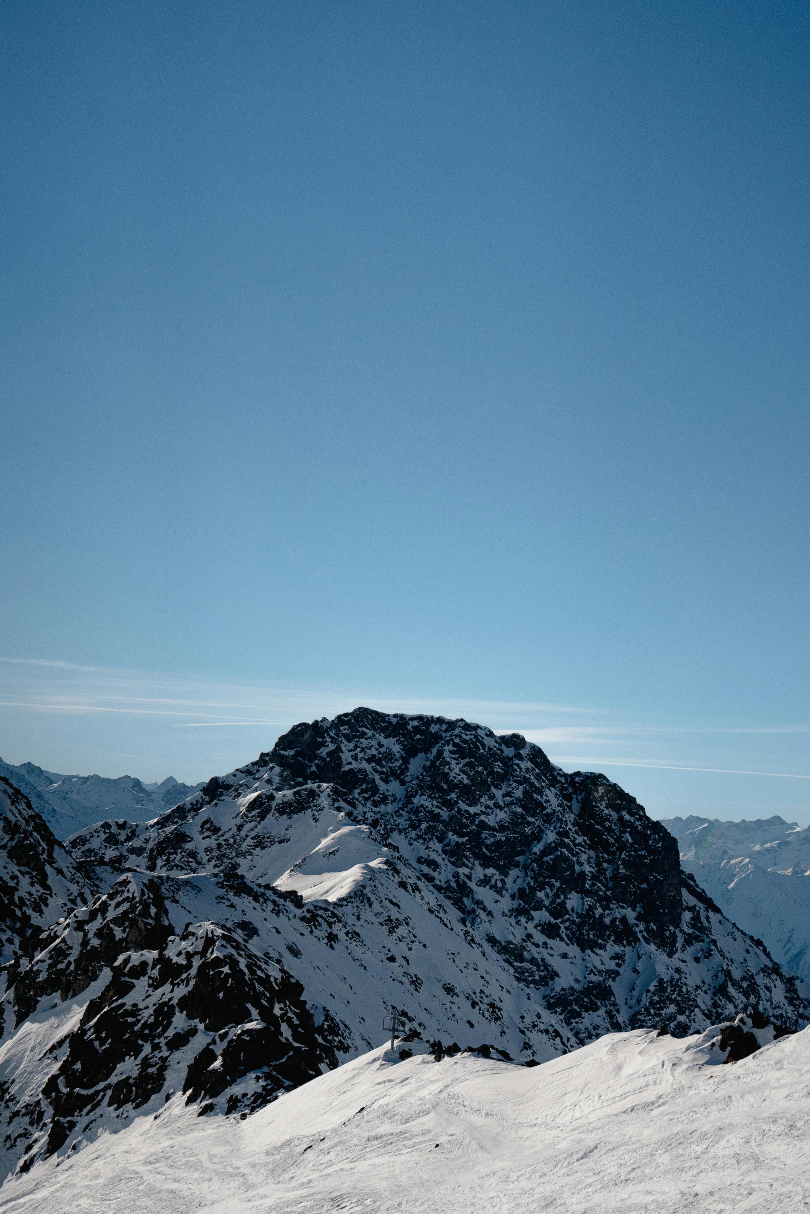 Snow Covered Rock Formation Under Blue Sky · Free Stock Photo