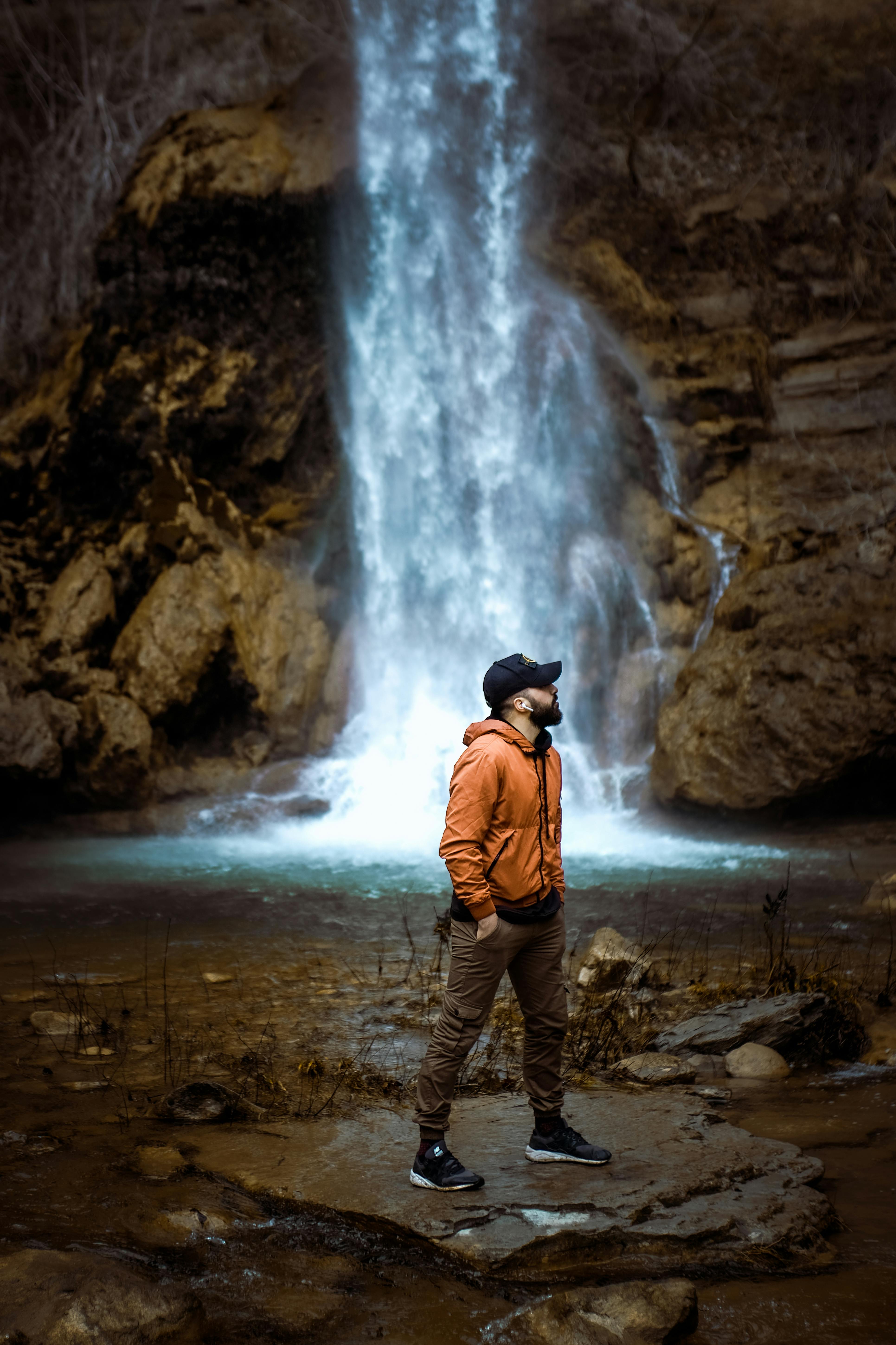 Man Standing in Front of Waterfall · Free Stock Photo