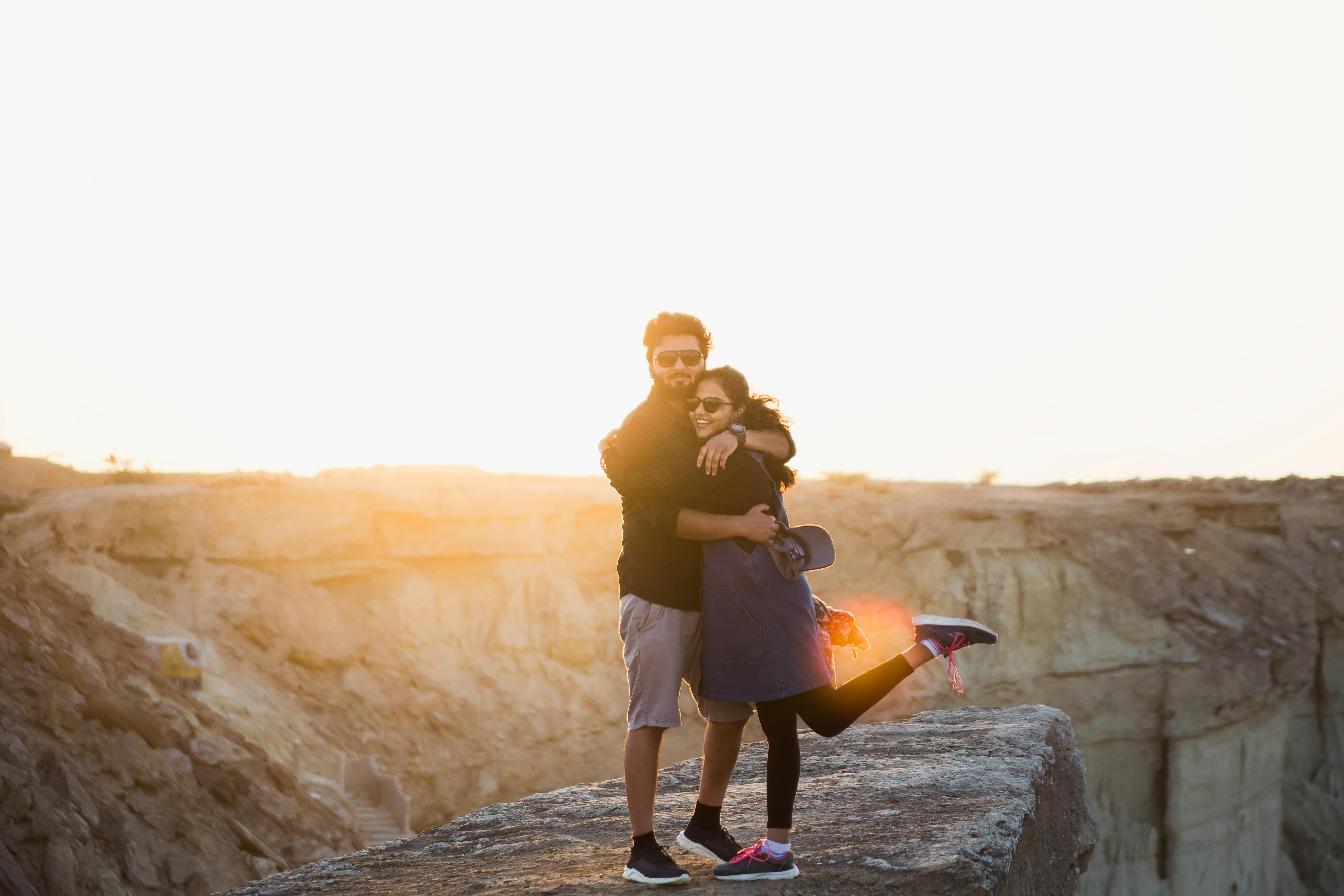 A Couple Hugging Each Other while Standing Near the Cliff · Free Stock ...
