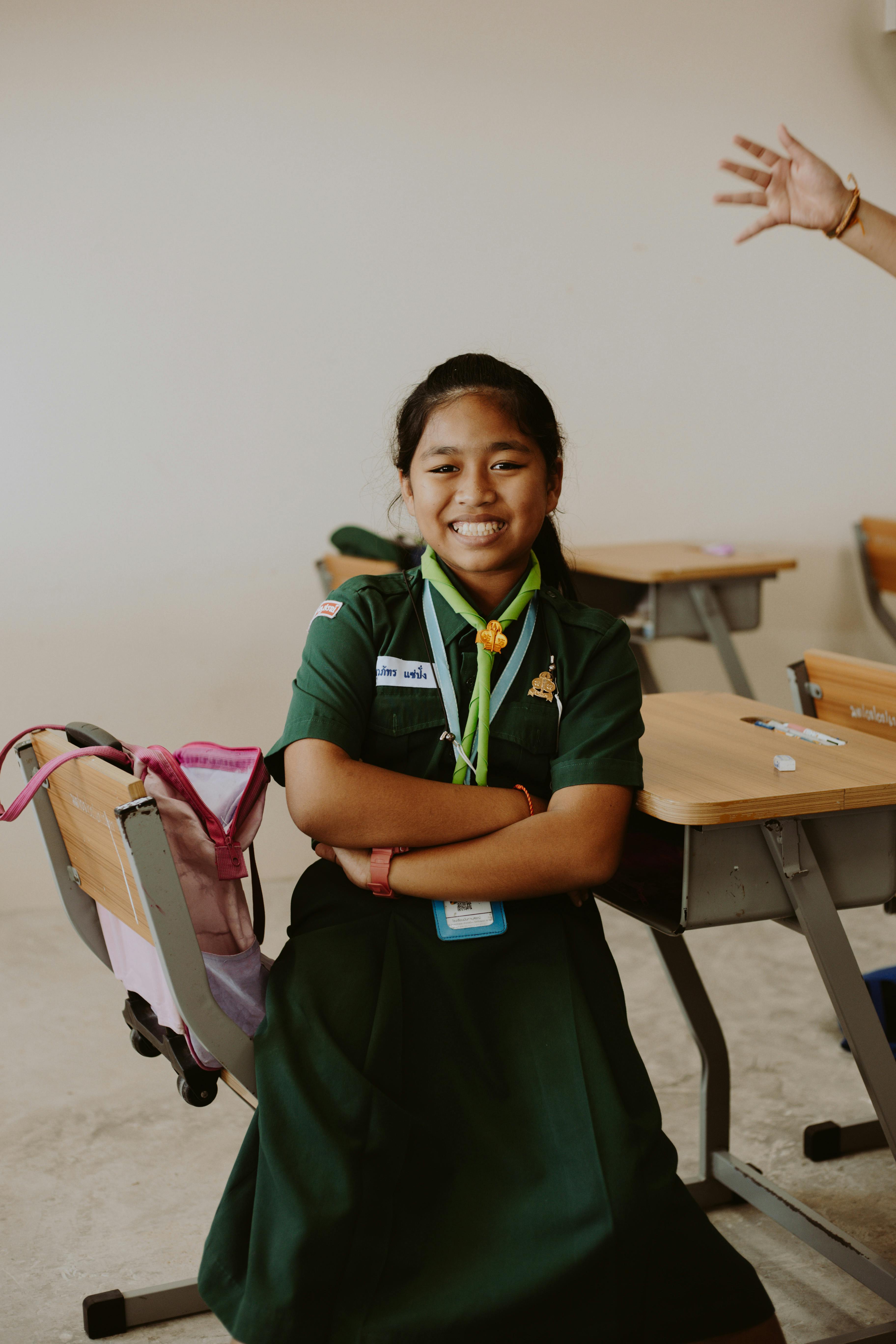 Smiling Girl in her Green School Uniform · Free Stock Photo