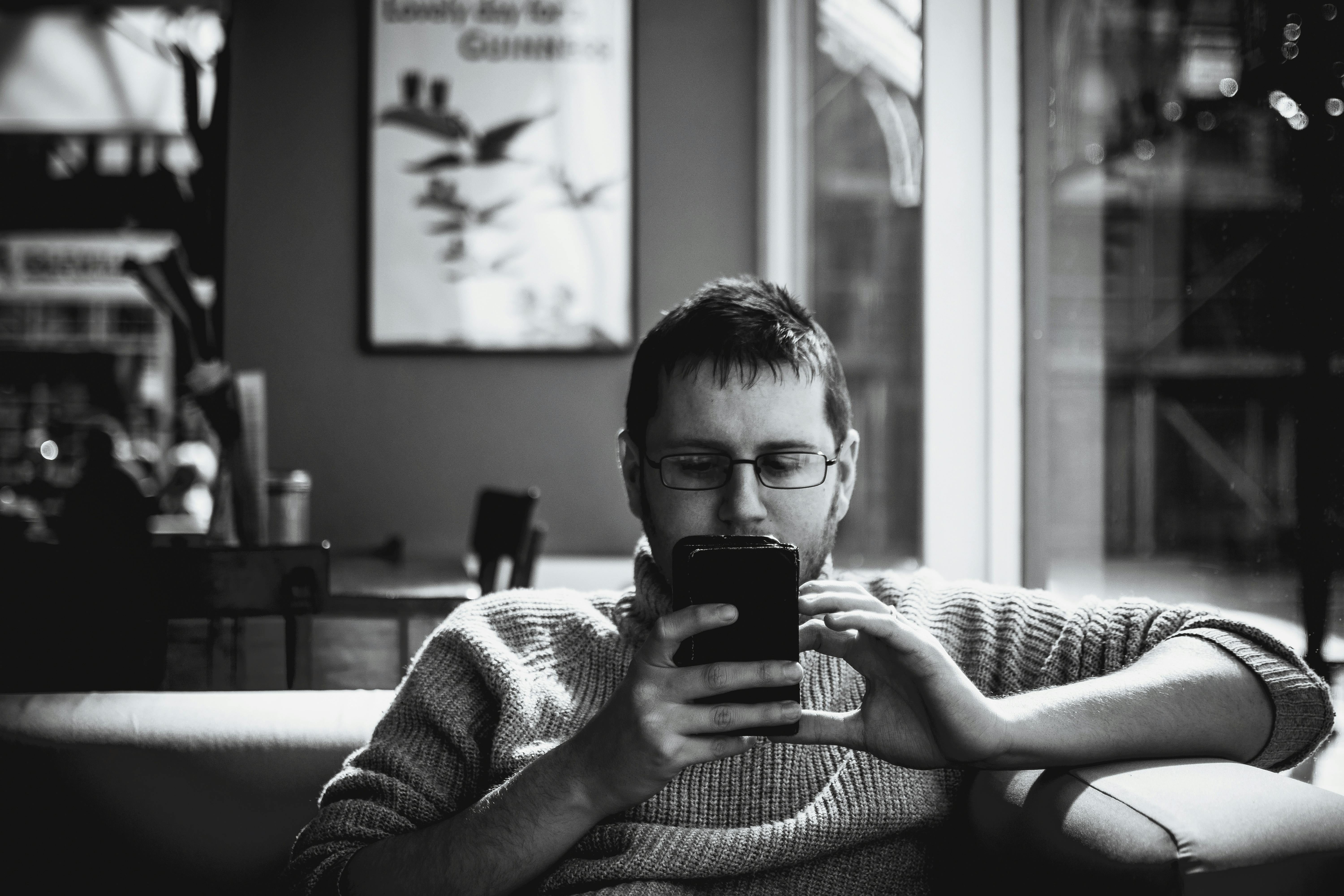 Man Holding Phone Grayscale Photography · Free Stock Photo