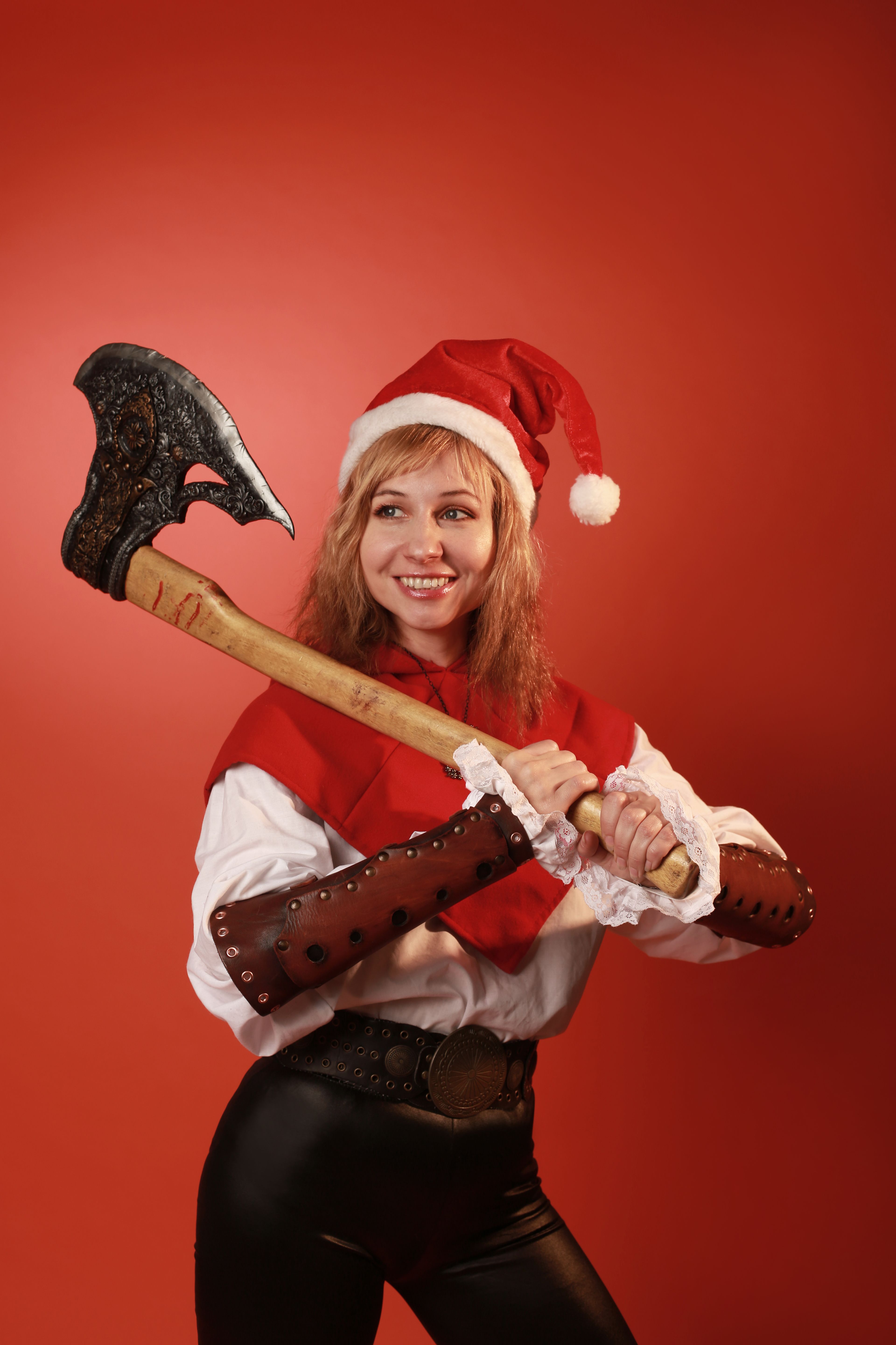 Woman Wearing a Santa Hat Holding Axe · Free Stock Photo