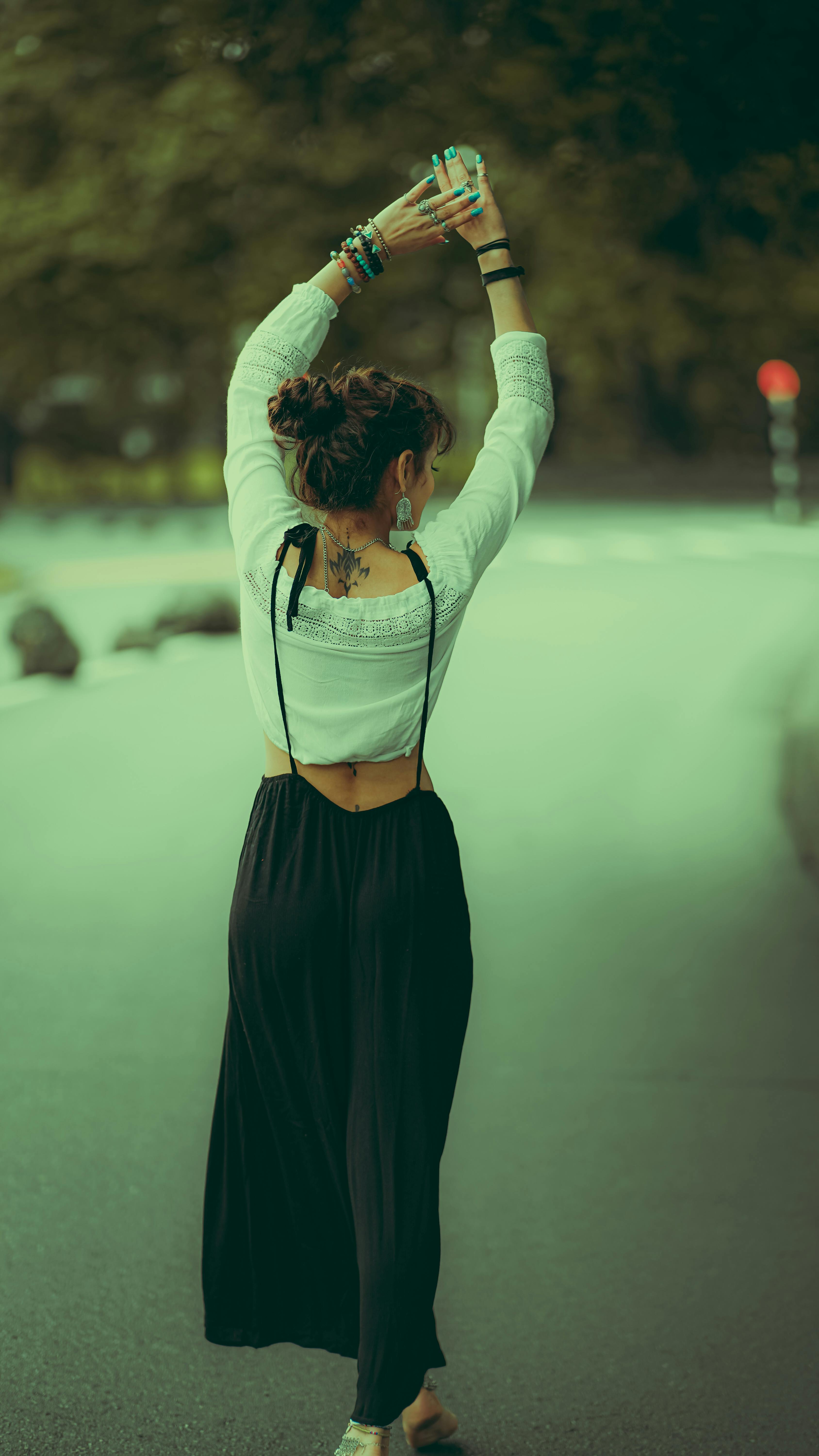 Back View of a Woman Walking on a Road · Free Stock Photo