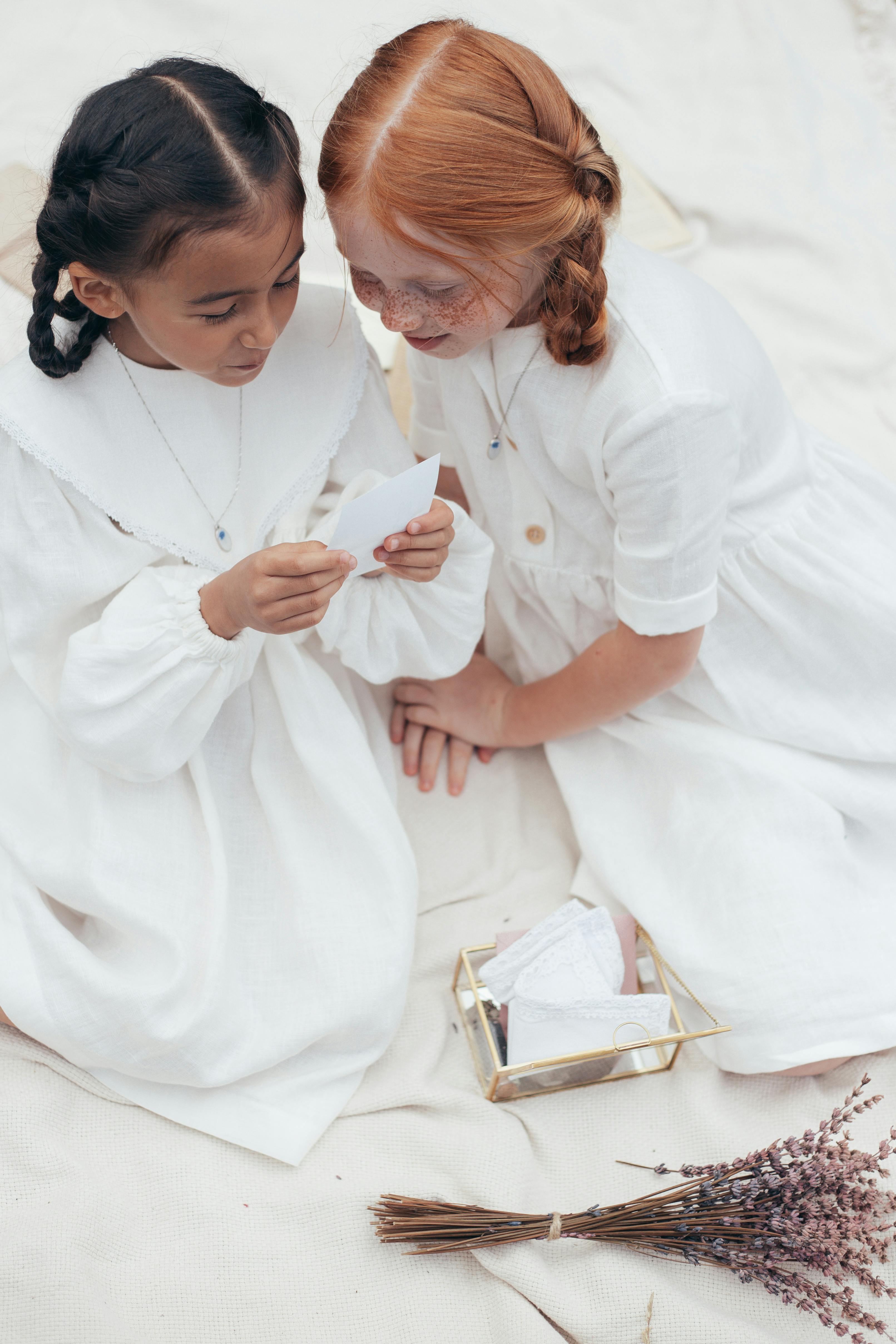 Girl in White Dress Holding White Paper · Free Stock Photo