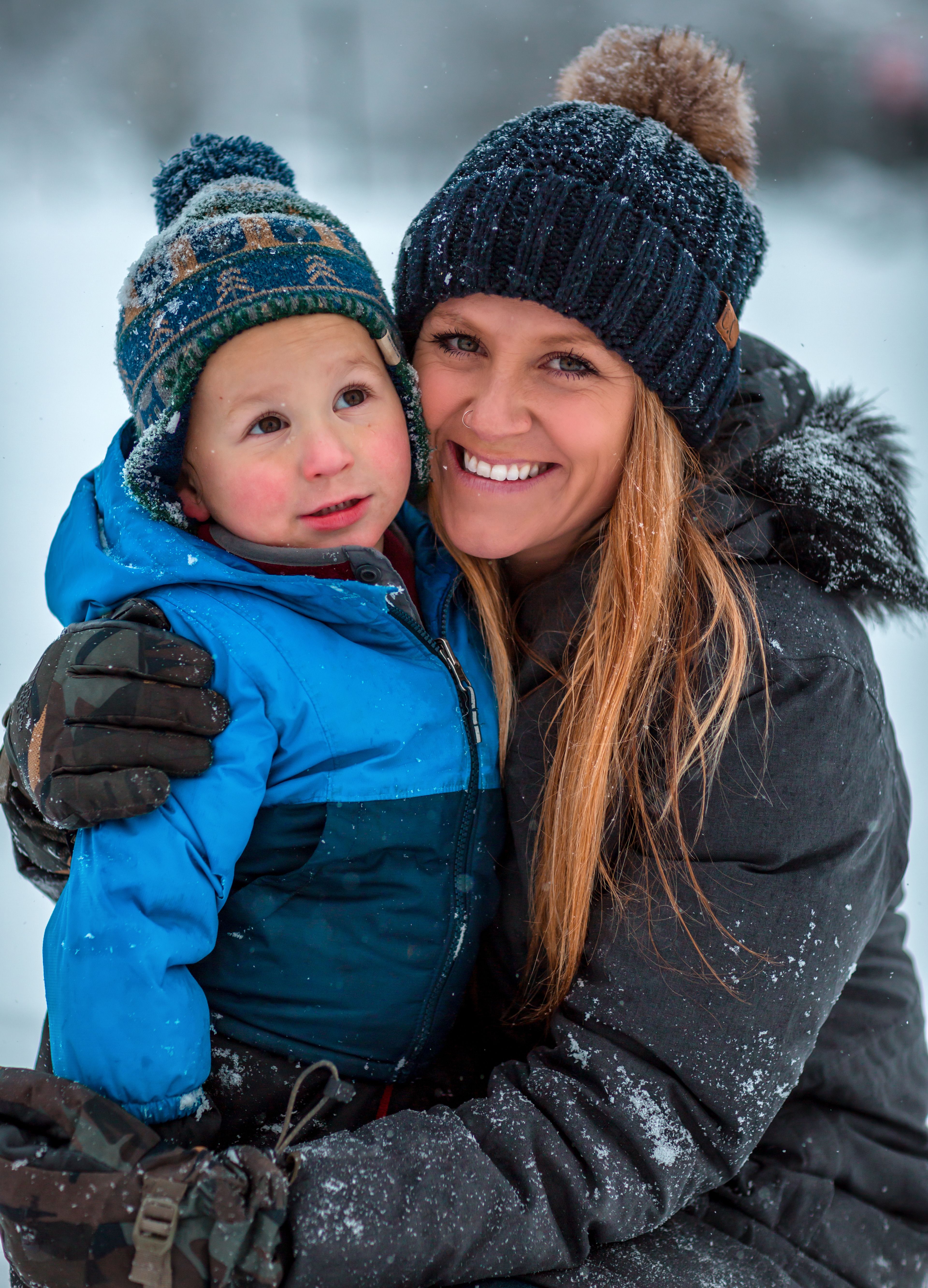 Woman in Black Jacket Hugging Boy in Blue Jacket · Free Stock Photo